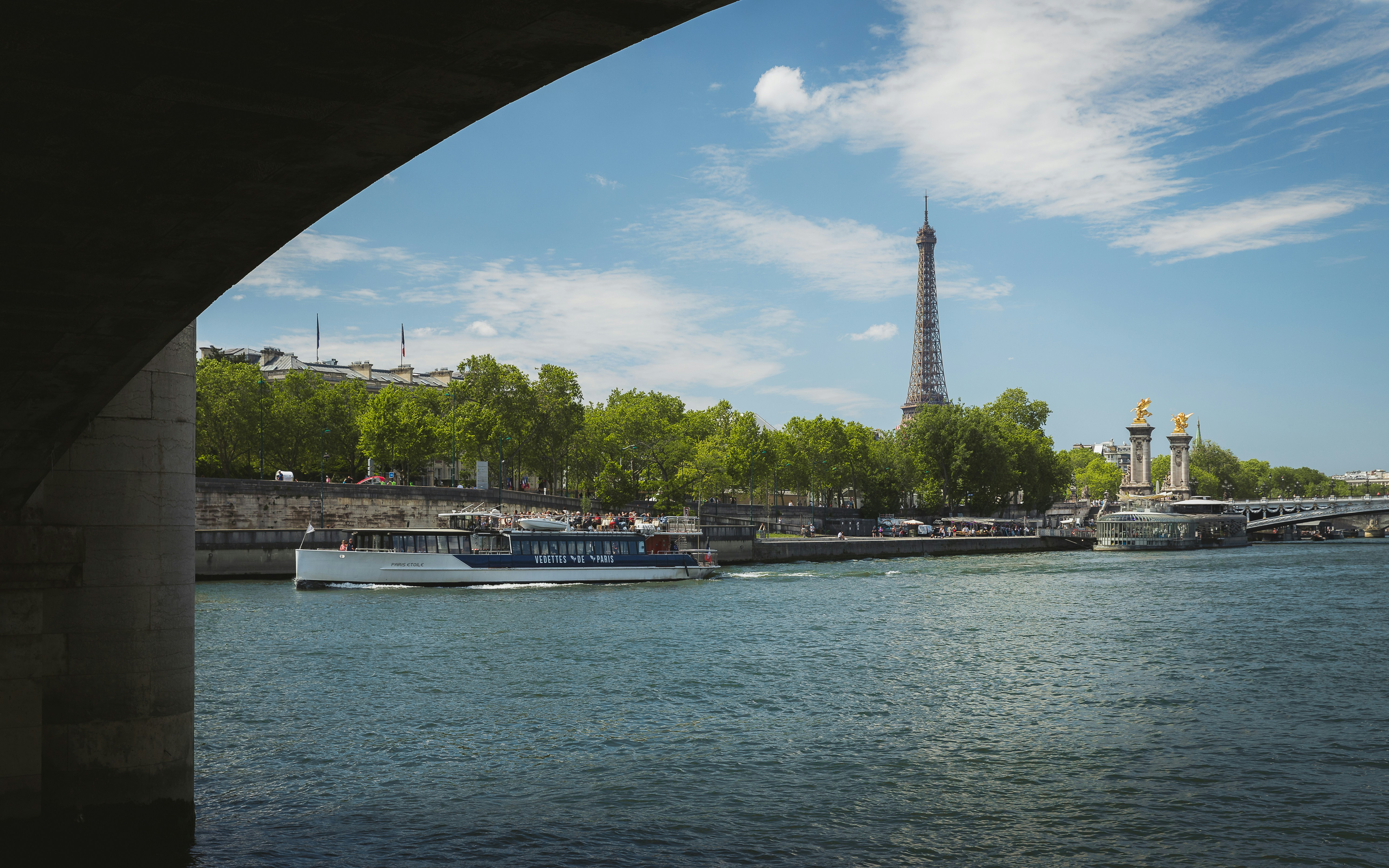Bridge Arc and River Parade under Parisian Sky