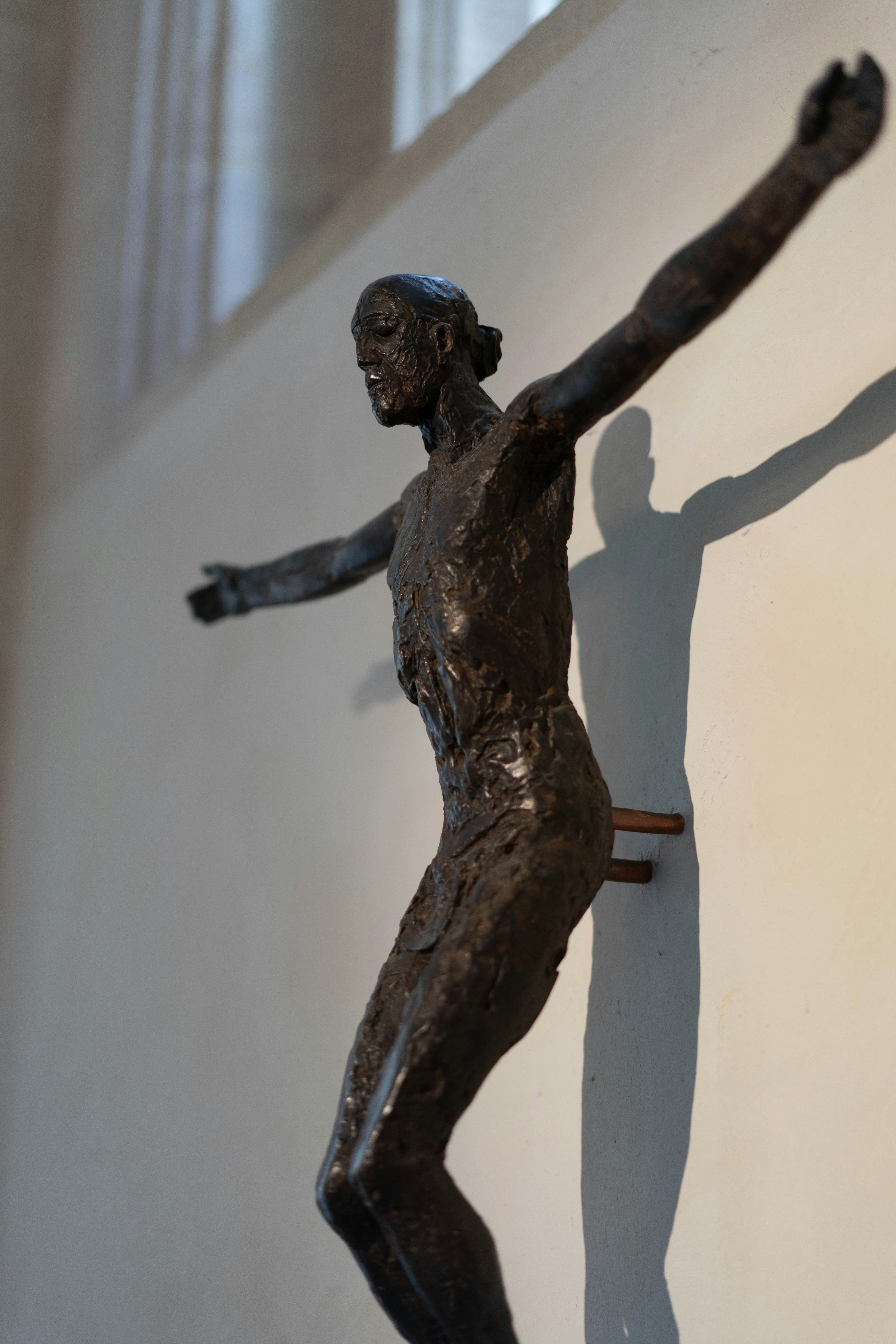 Bronze Silhouette: A Dynamic Shadow of Figure with Outstretched Arms