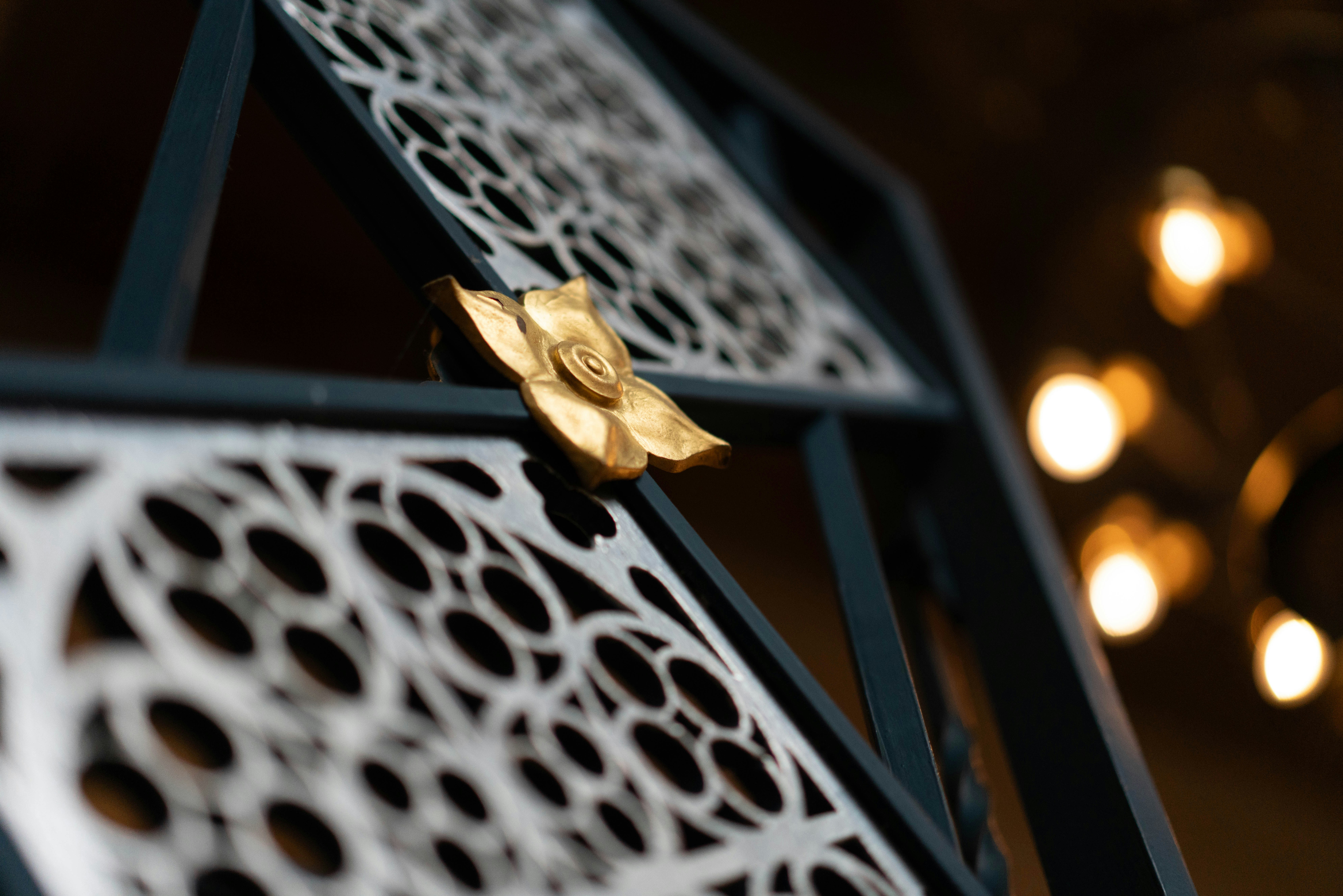 Ornate gate latch in warm glow