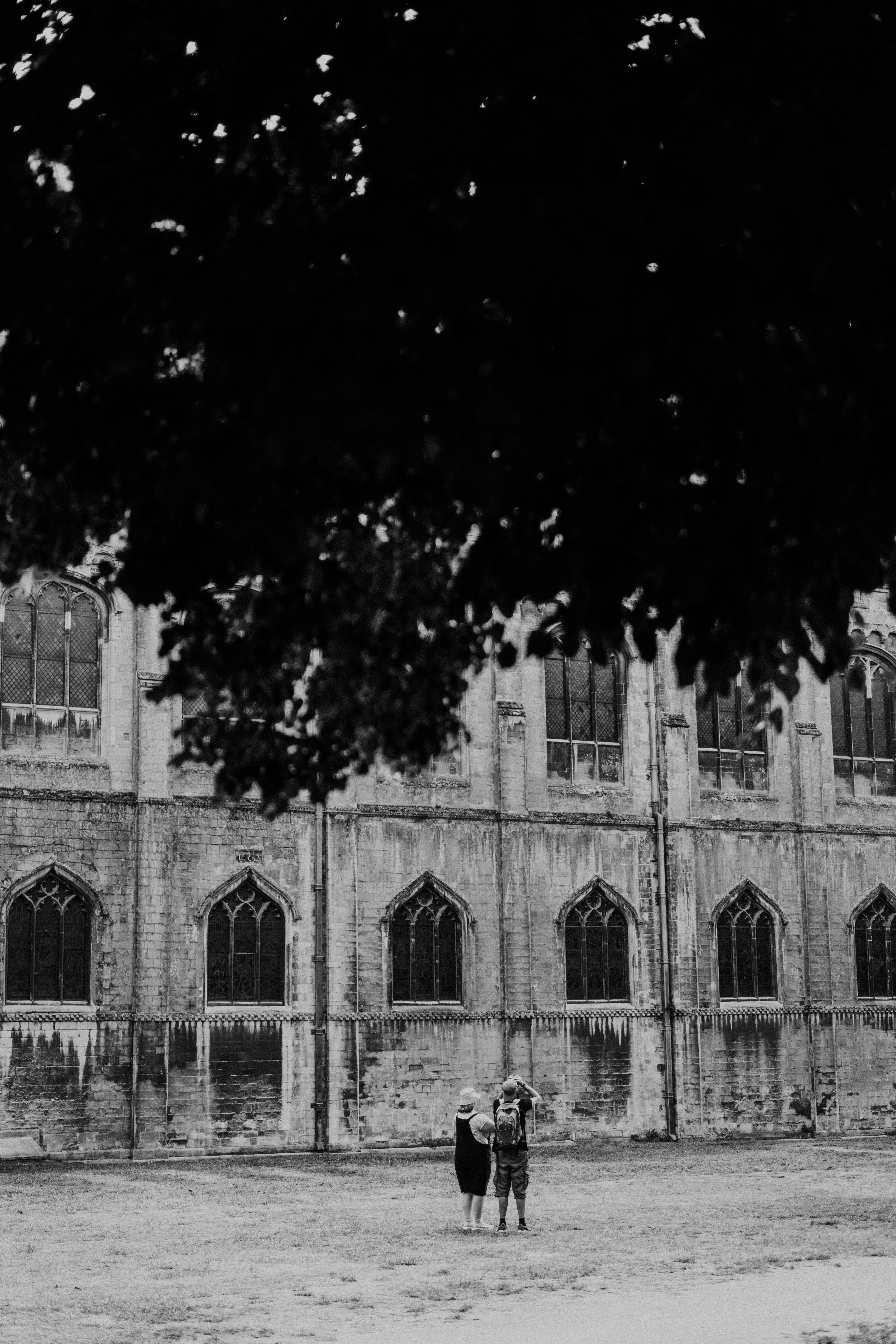 Couple in front of a ivy-draped Gothic façade