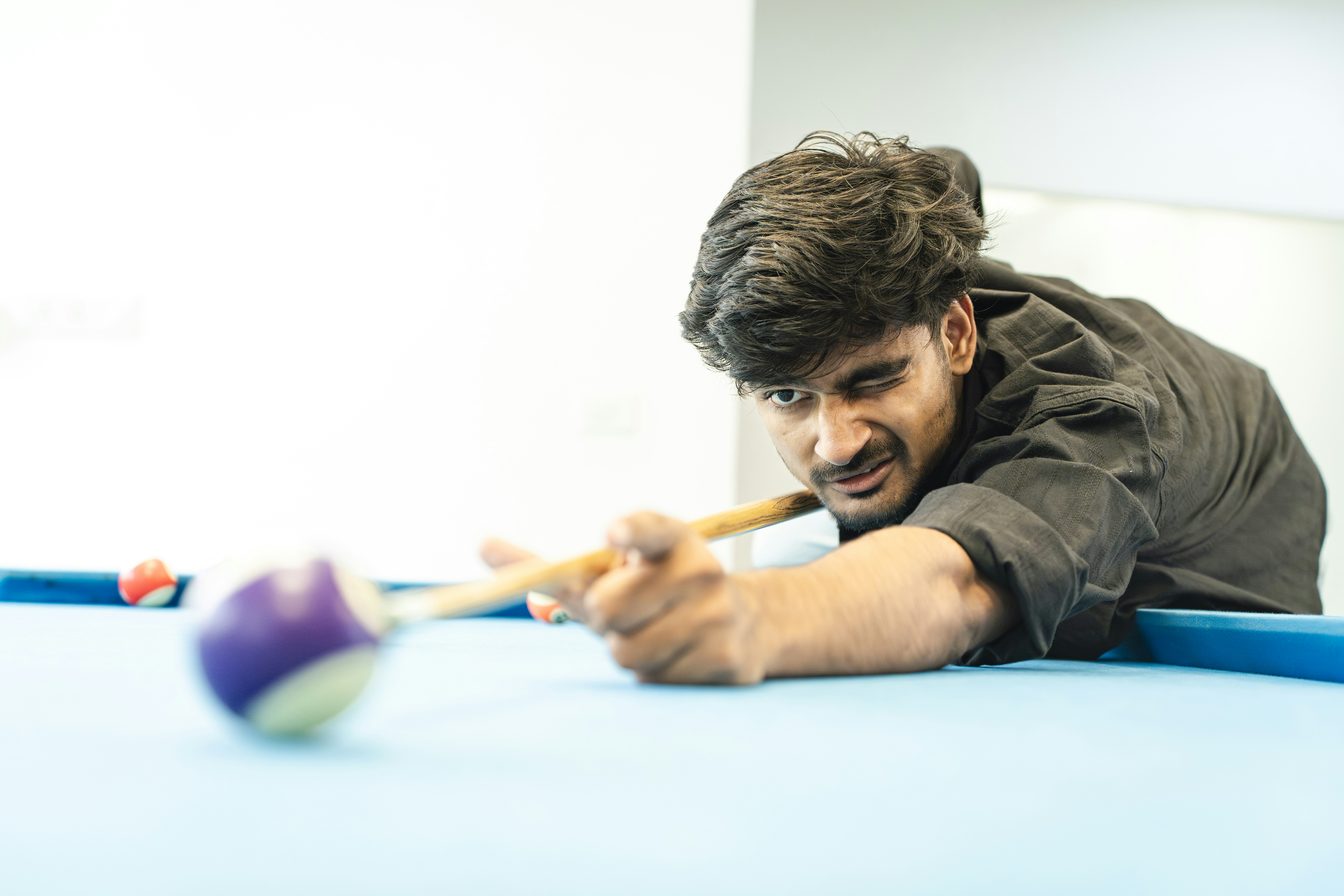 Precision in Play: A Focused Shot Across the Pool Table