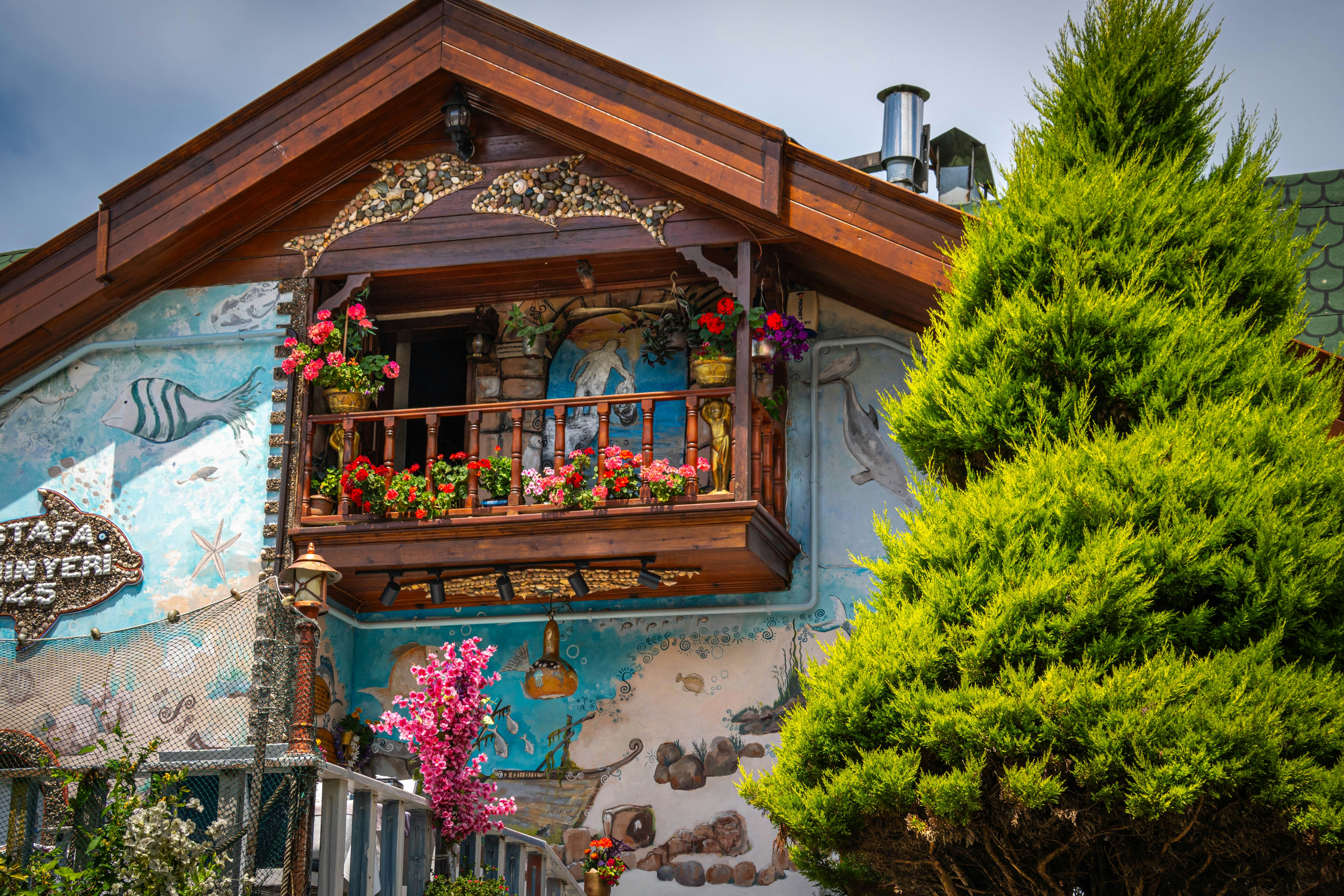 Balcony Blooms Over a Painted Chalet