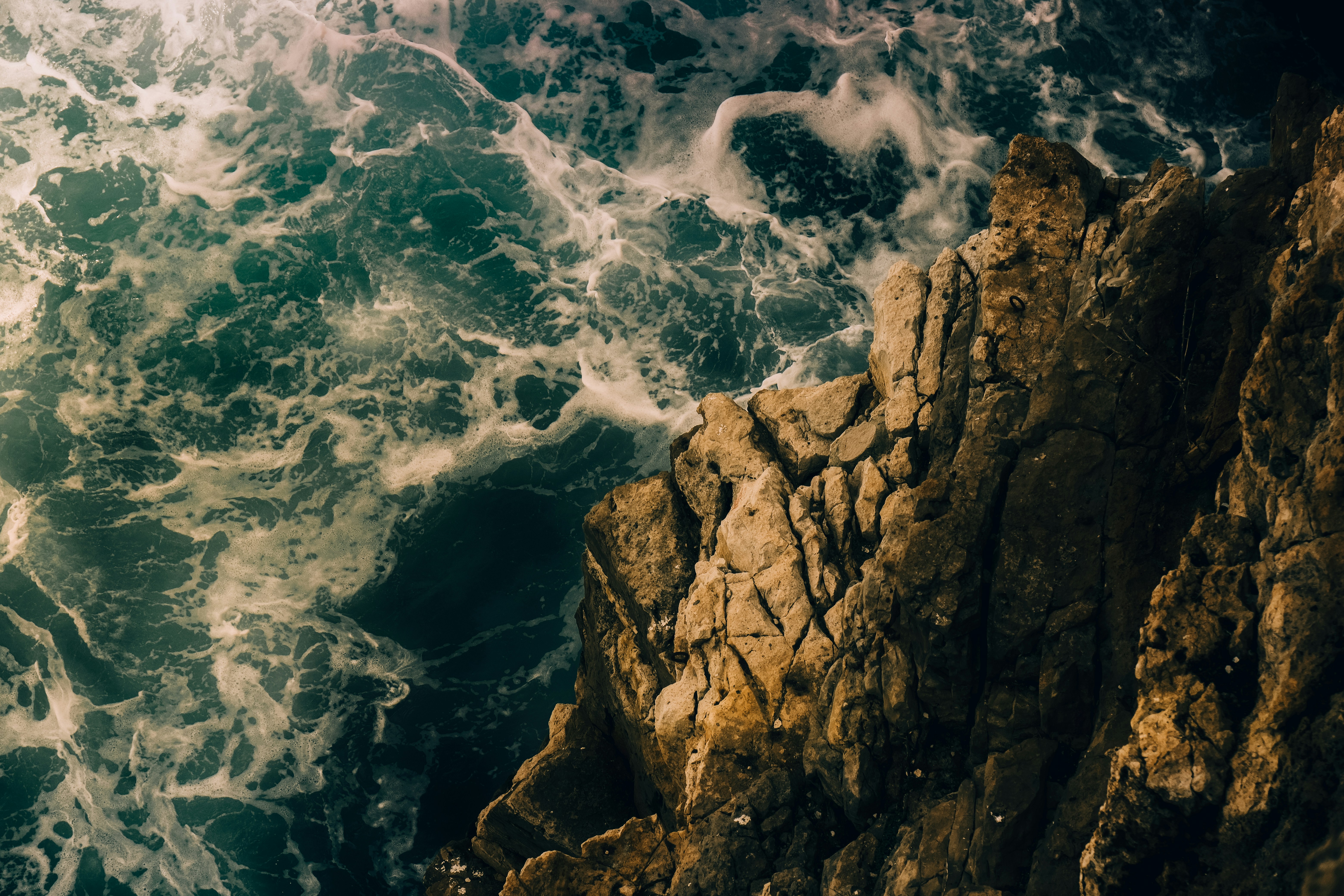 Edge of the Abyss: Sunlit Cliff and Rushing Sea