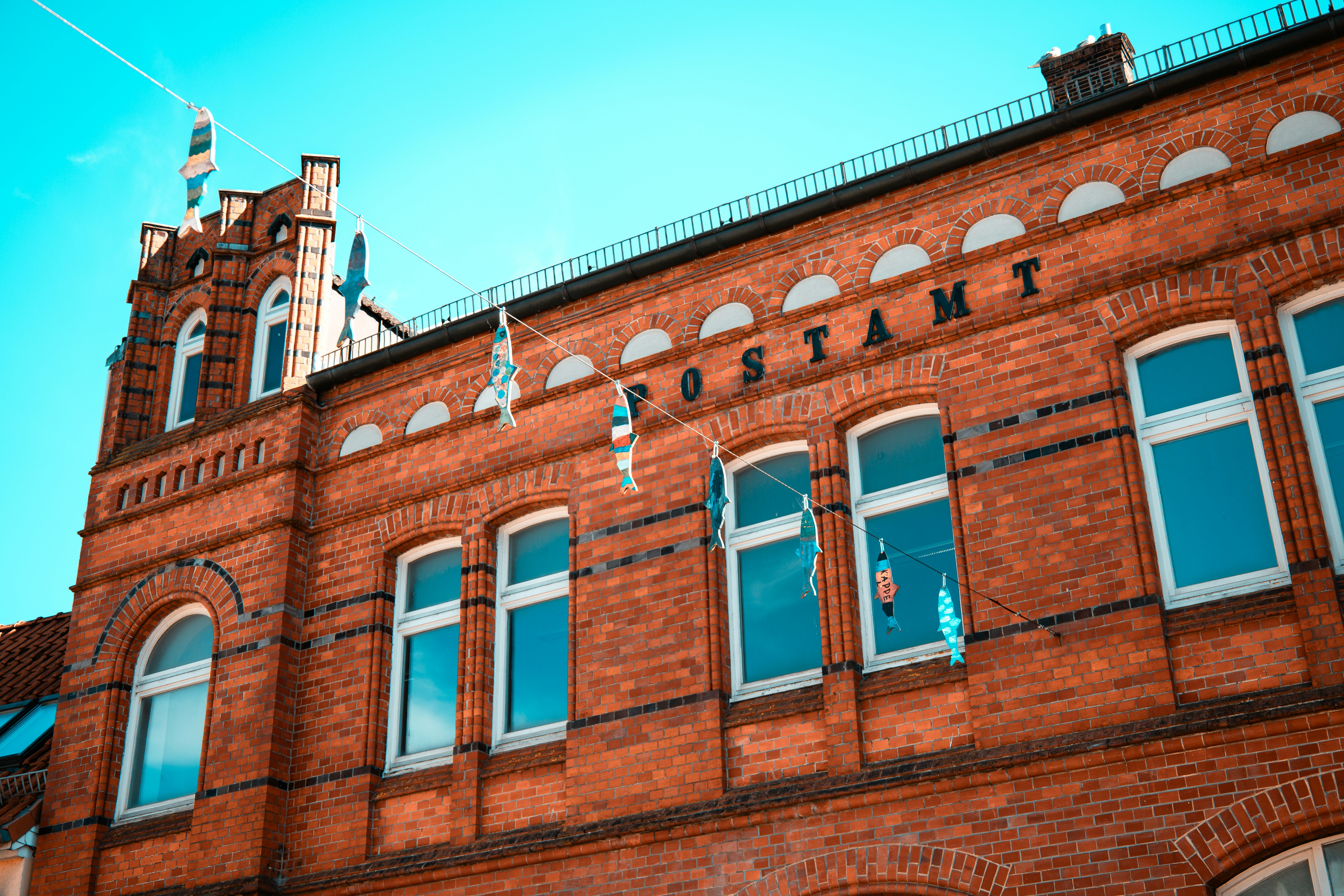 Sunlit Brick Facade of a Historic Station Leans into the Sky