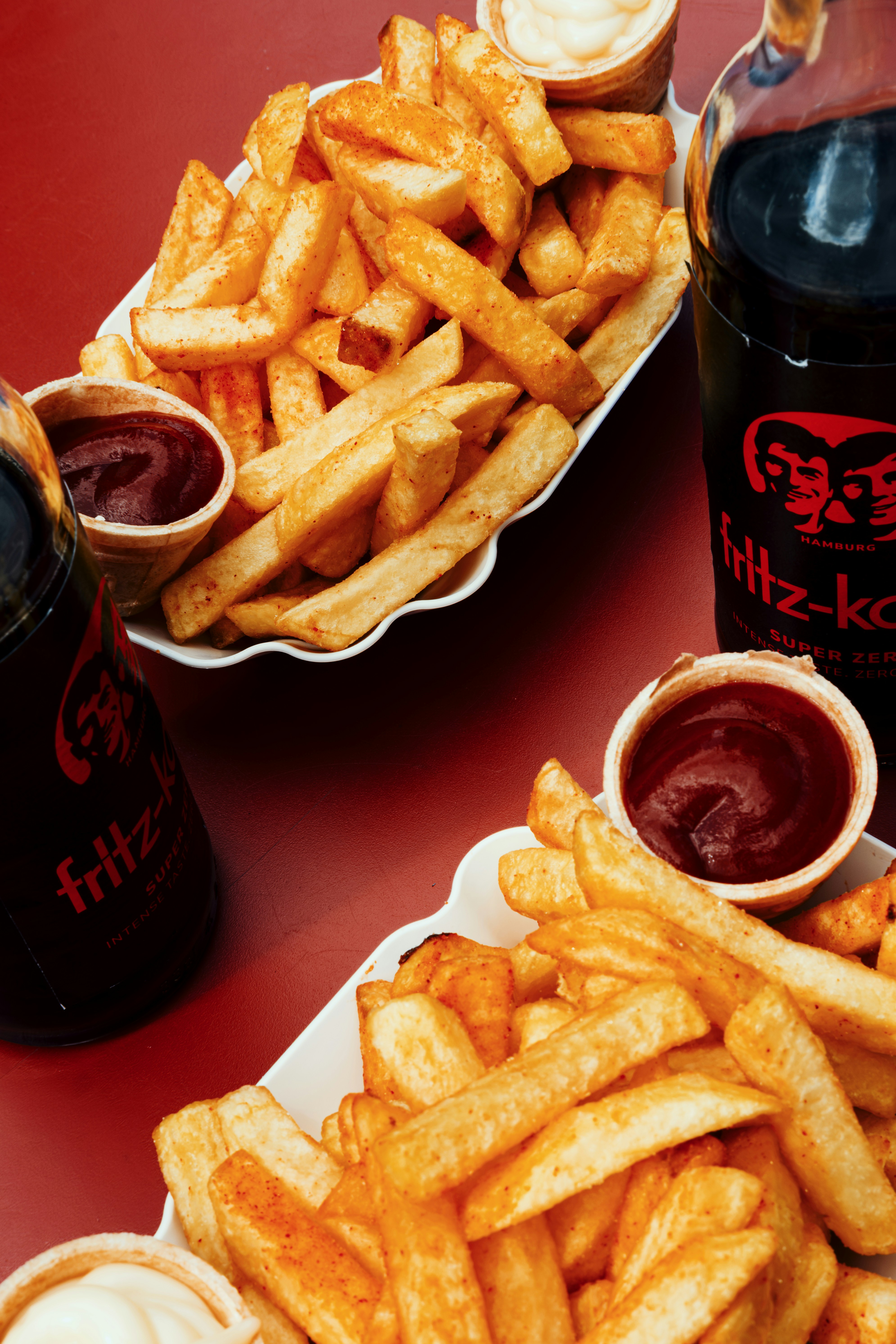 Crispy Fries and Dipping Sauces on a Red Table