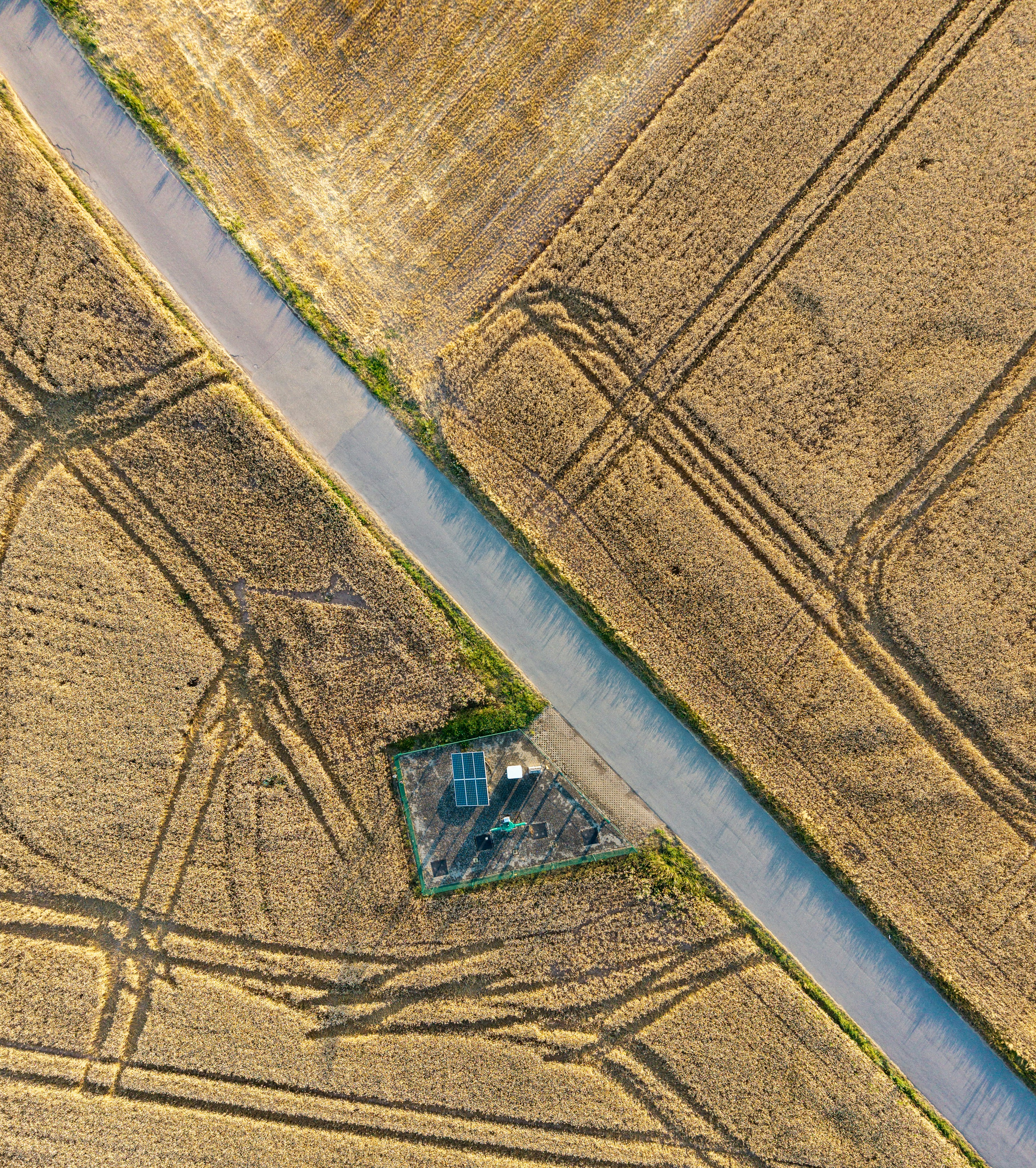 Aerial Veins: Field Patterns Framing a Stone Shelter
