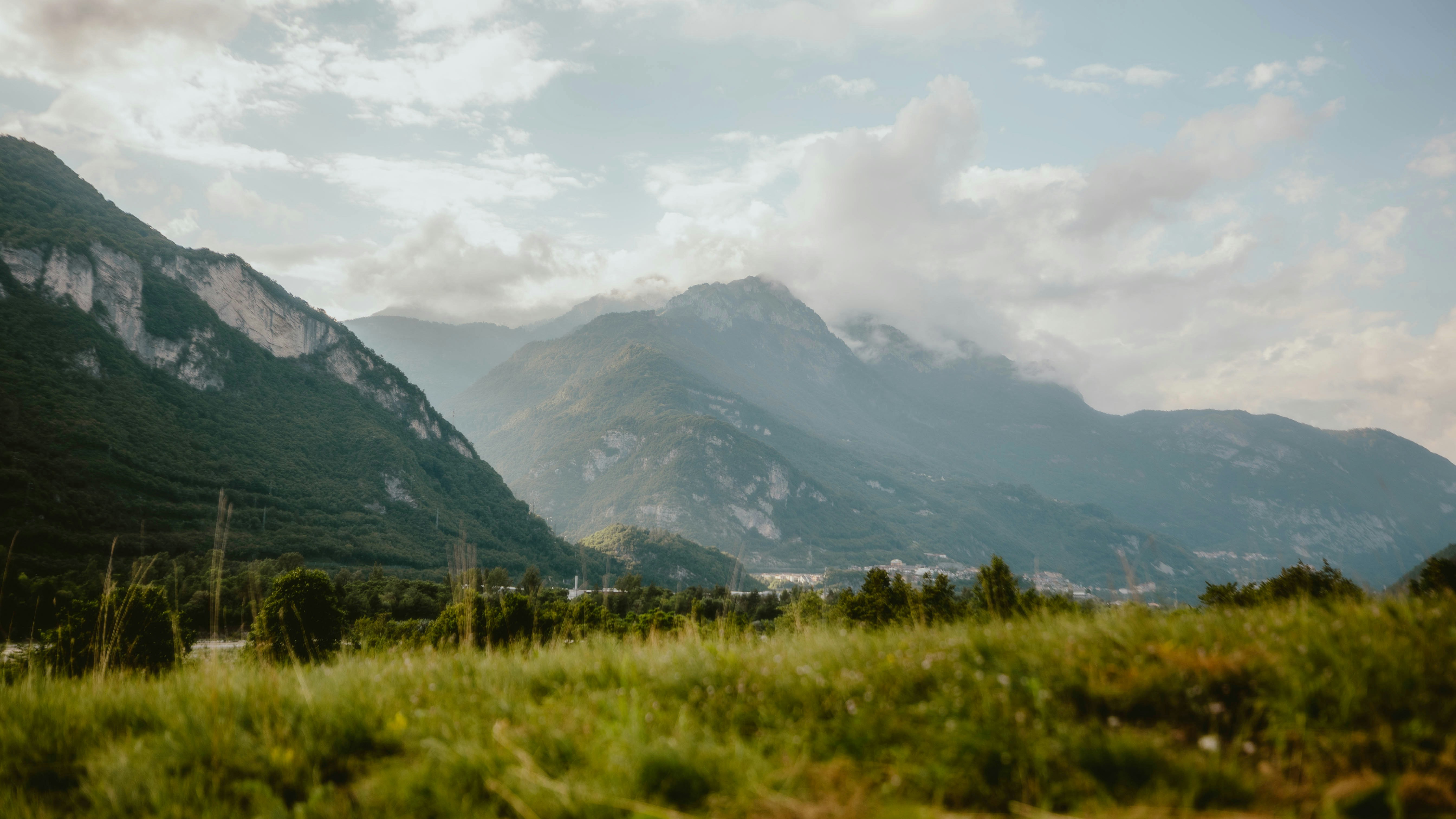 Quiet Valley Below Towering Peaks at Dusk
