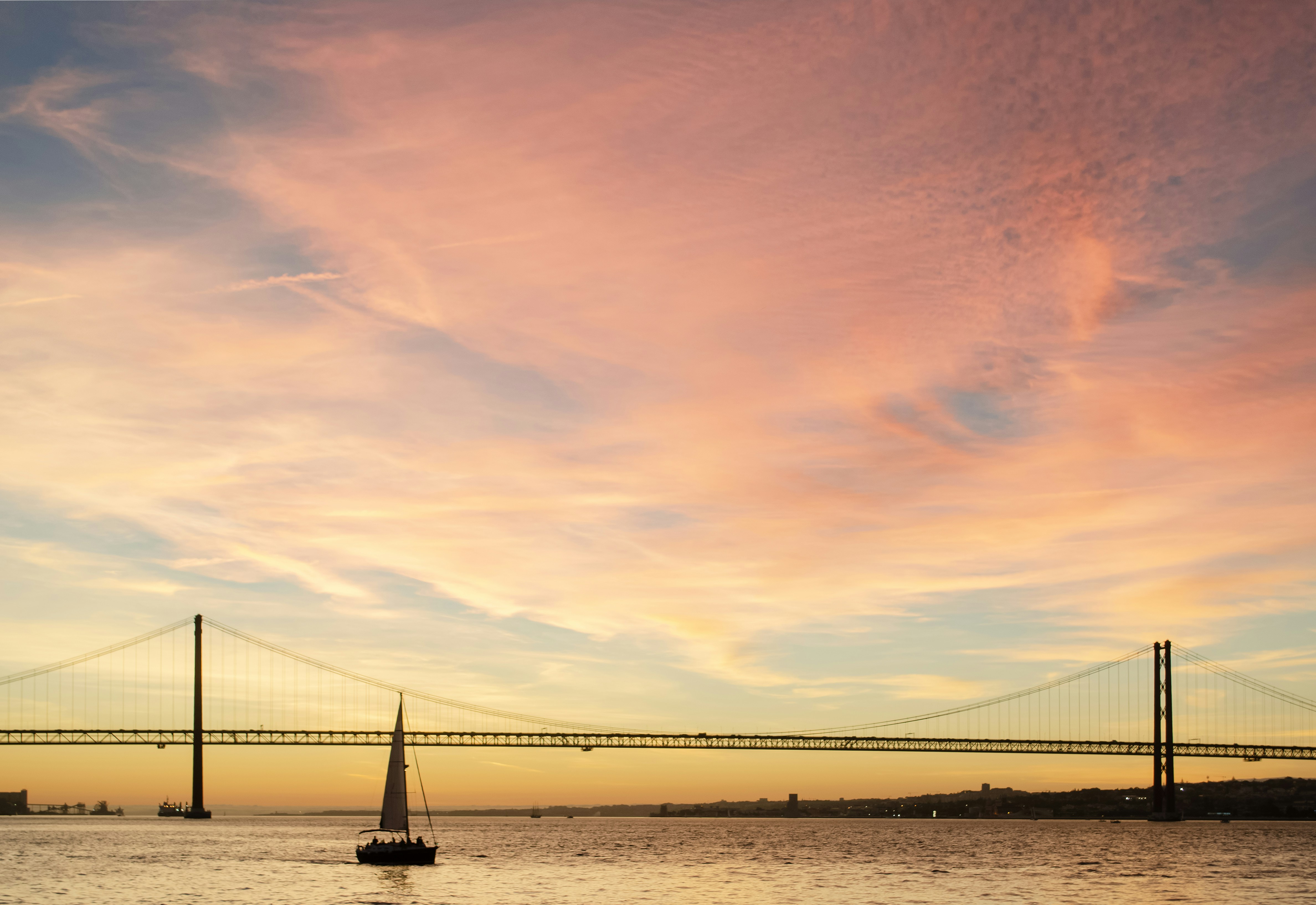 Sunset Span: A Quiet Boat Beneath a Risen Bridge