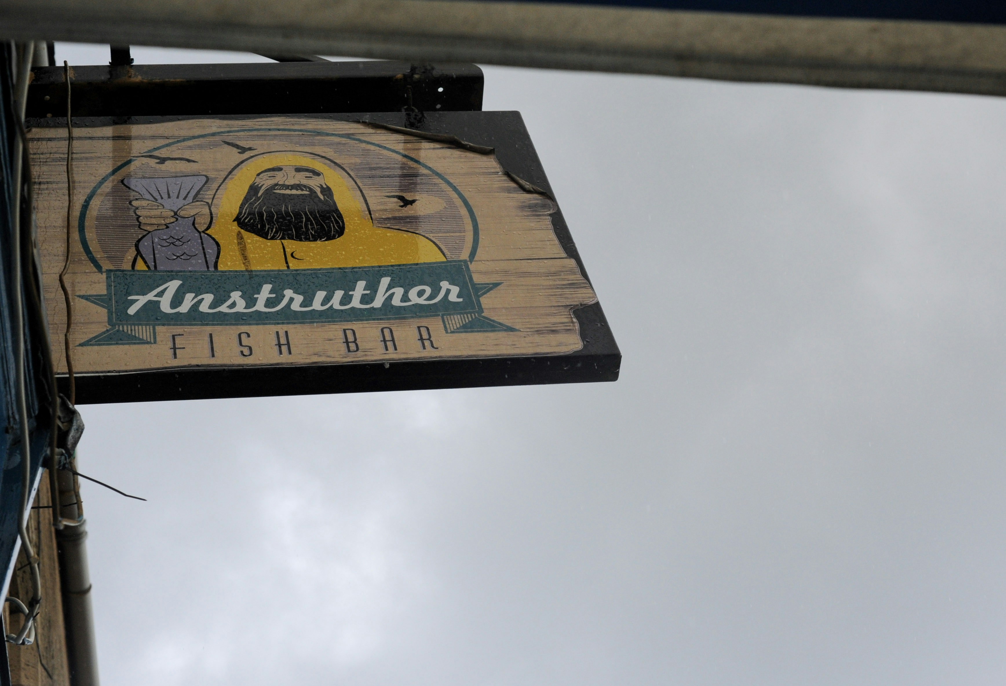 Anstruther Signboard: A Cheerful Fish Bar Illustration Basking in Soft Sky