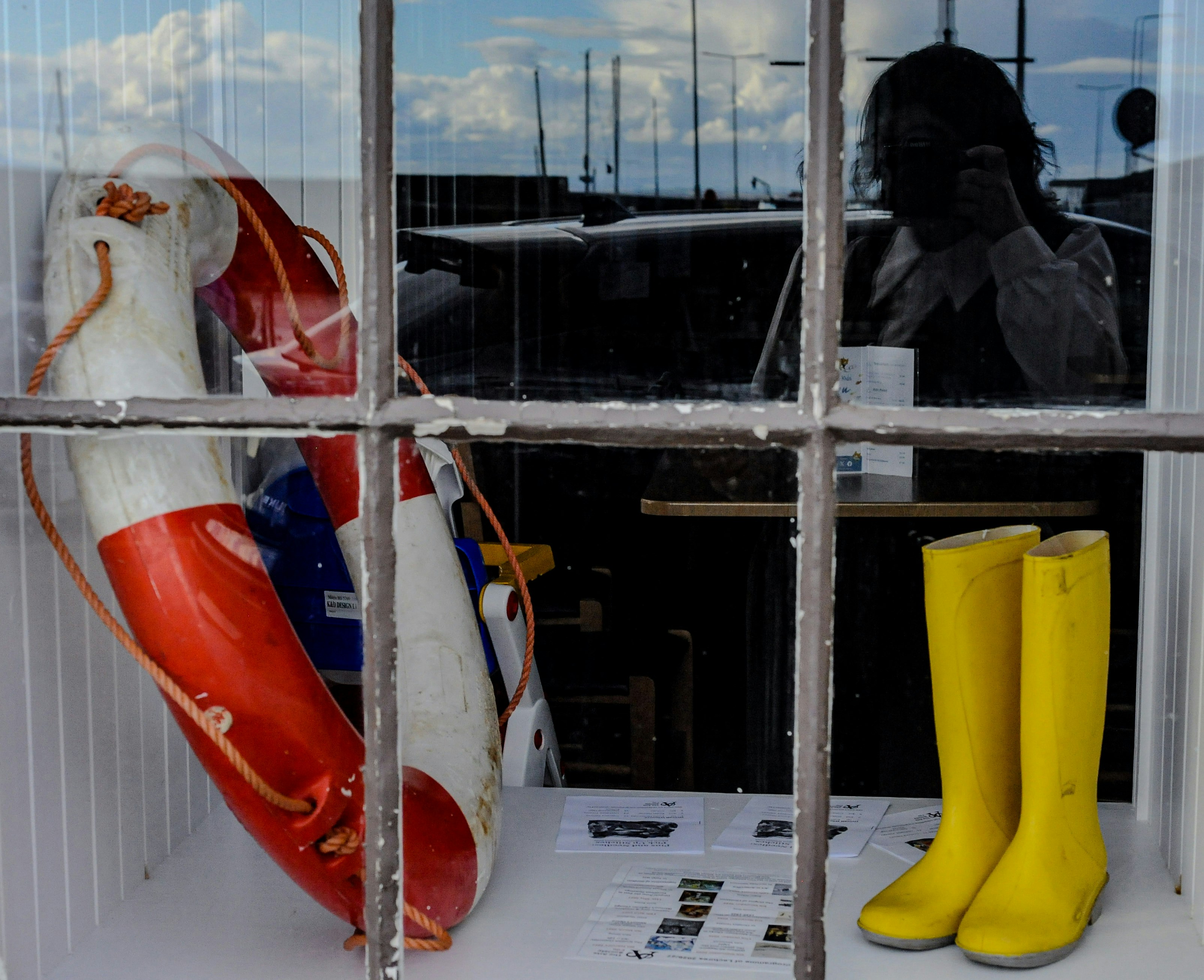 Bright Yellow Boots and Life Preserver in a Window Display