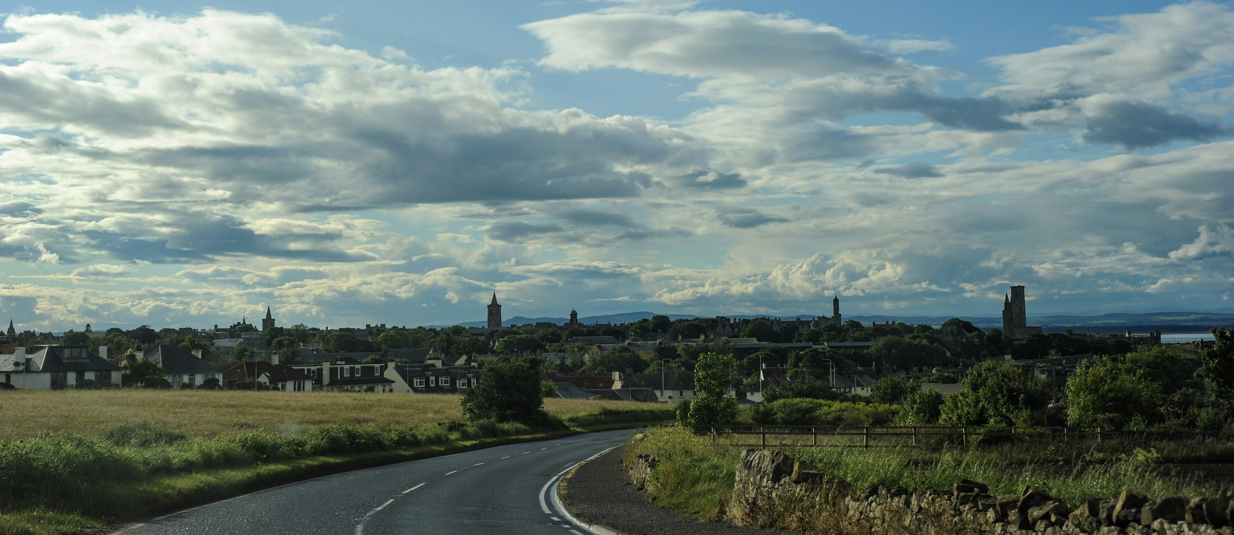 Country Road to a Quiet Town Under a Brooding Sky