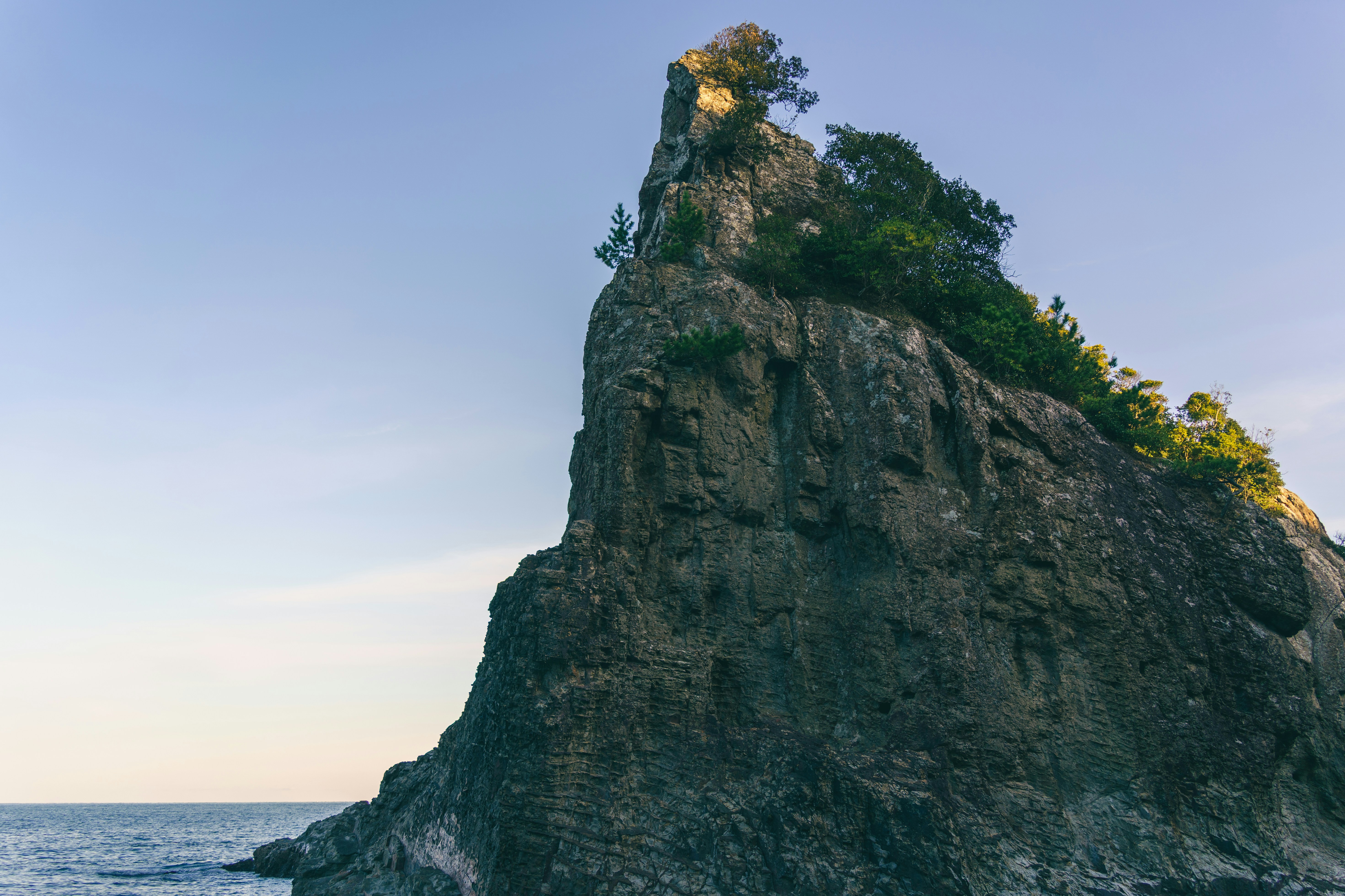 Sea-cliff Sentinel: A Lone Rock Rising Over Quiet Waters