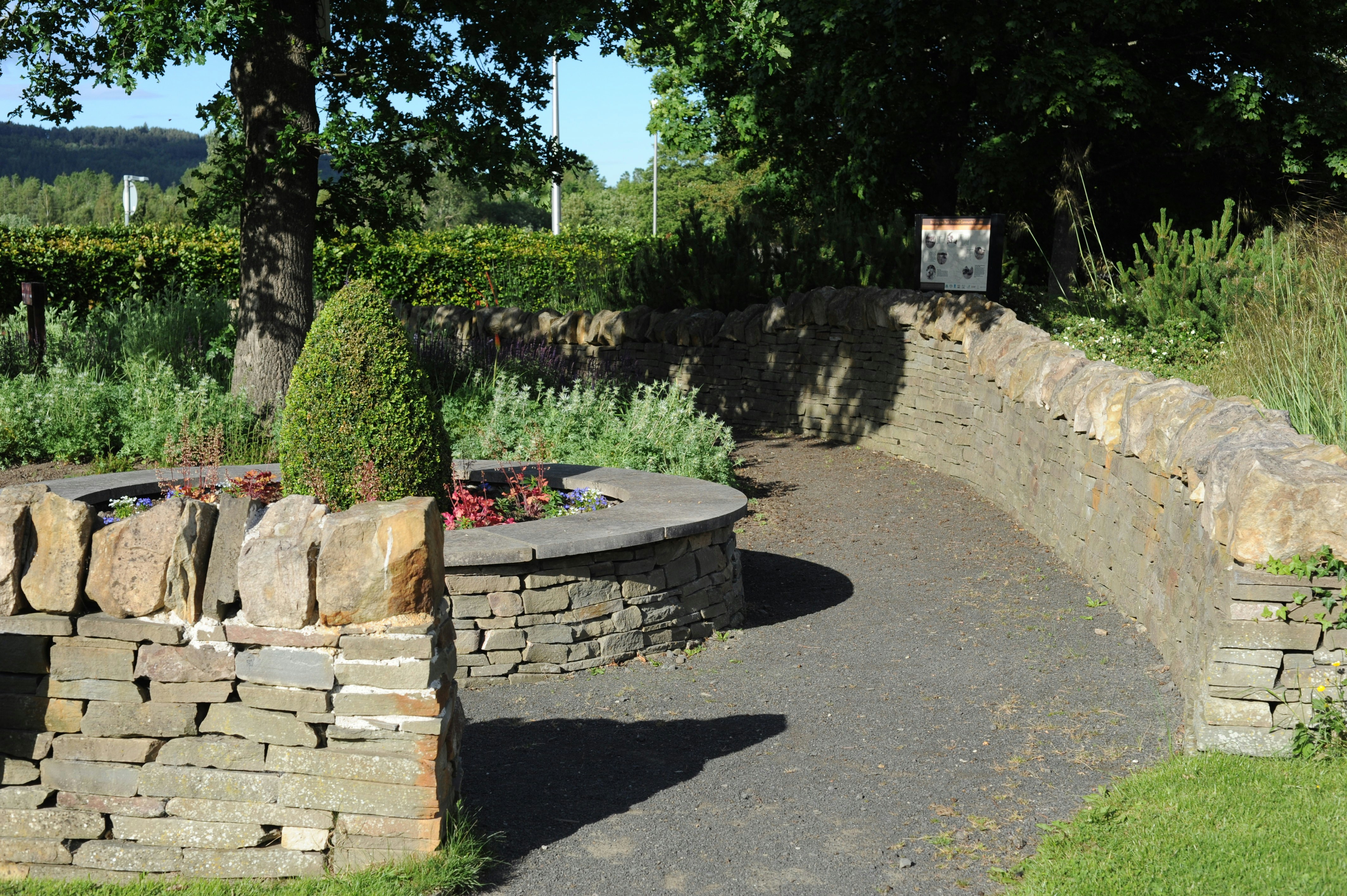 Stone Circle Garden Entrance Curving Toward Quiet Path