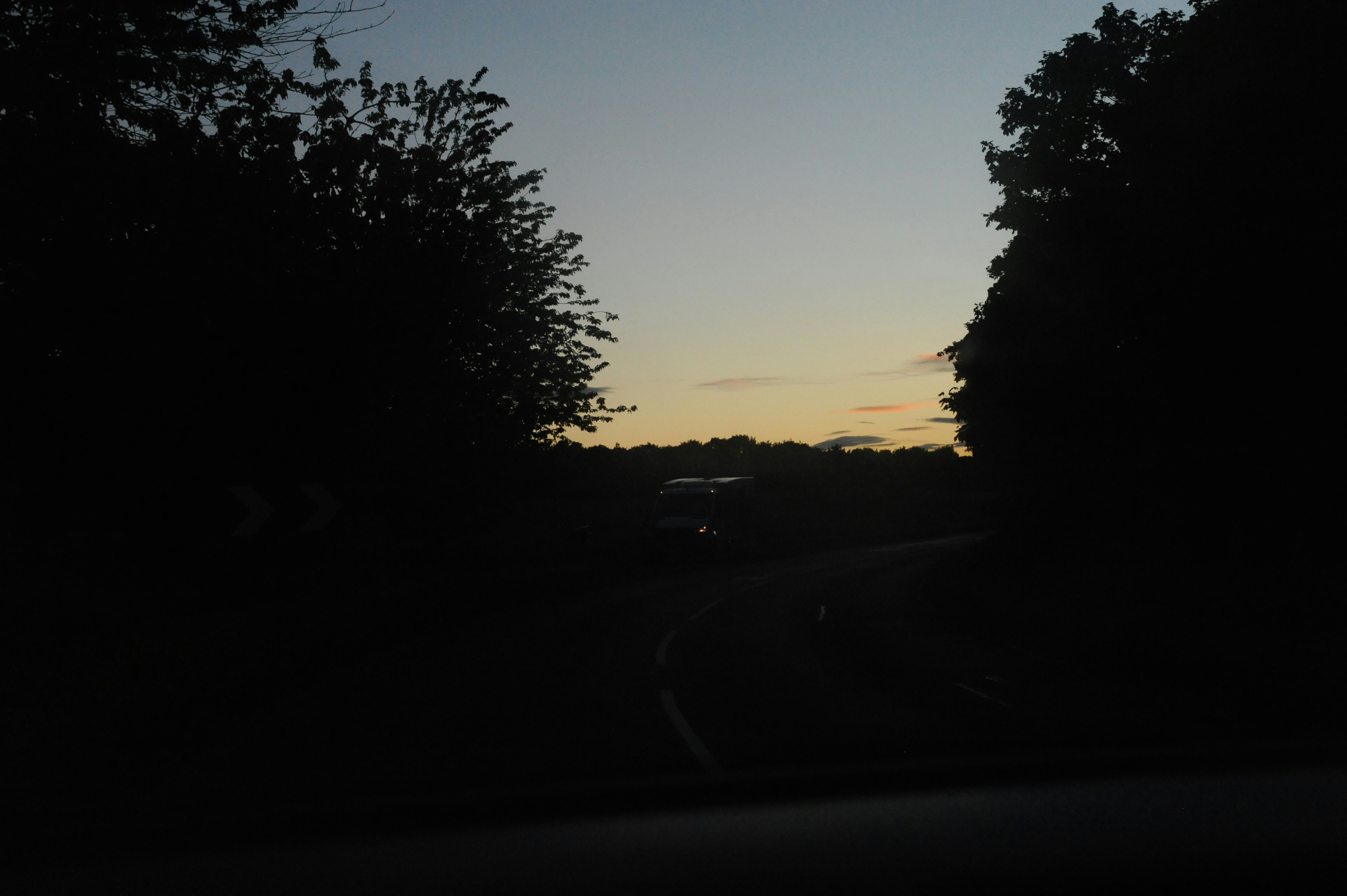 Dusk on a Quiet Road: silhouettes Framing the Horizon