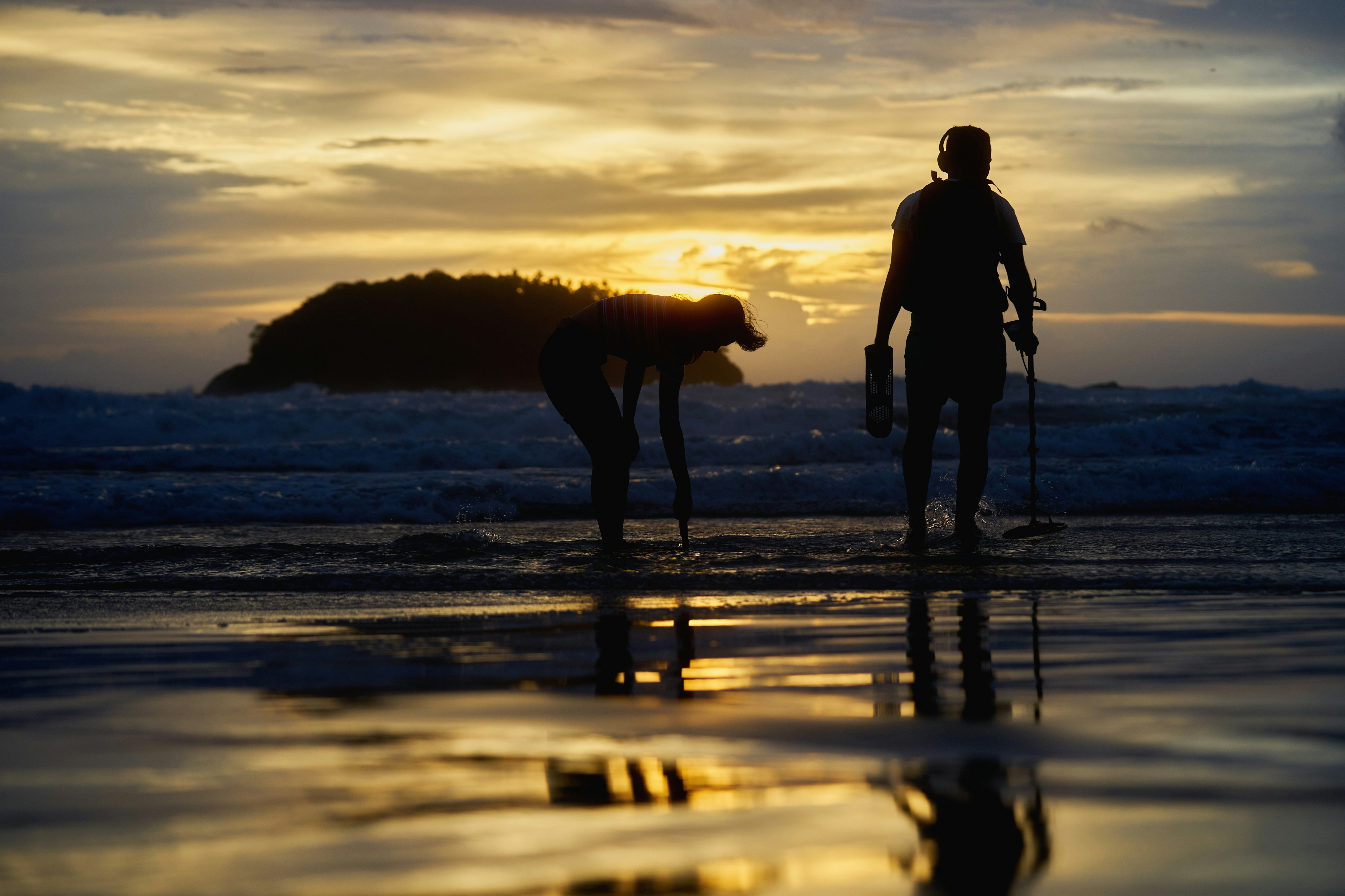 Dusk Silhouettes: Two Surfers At the Tidal Edge
