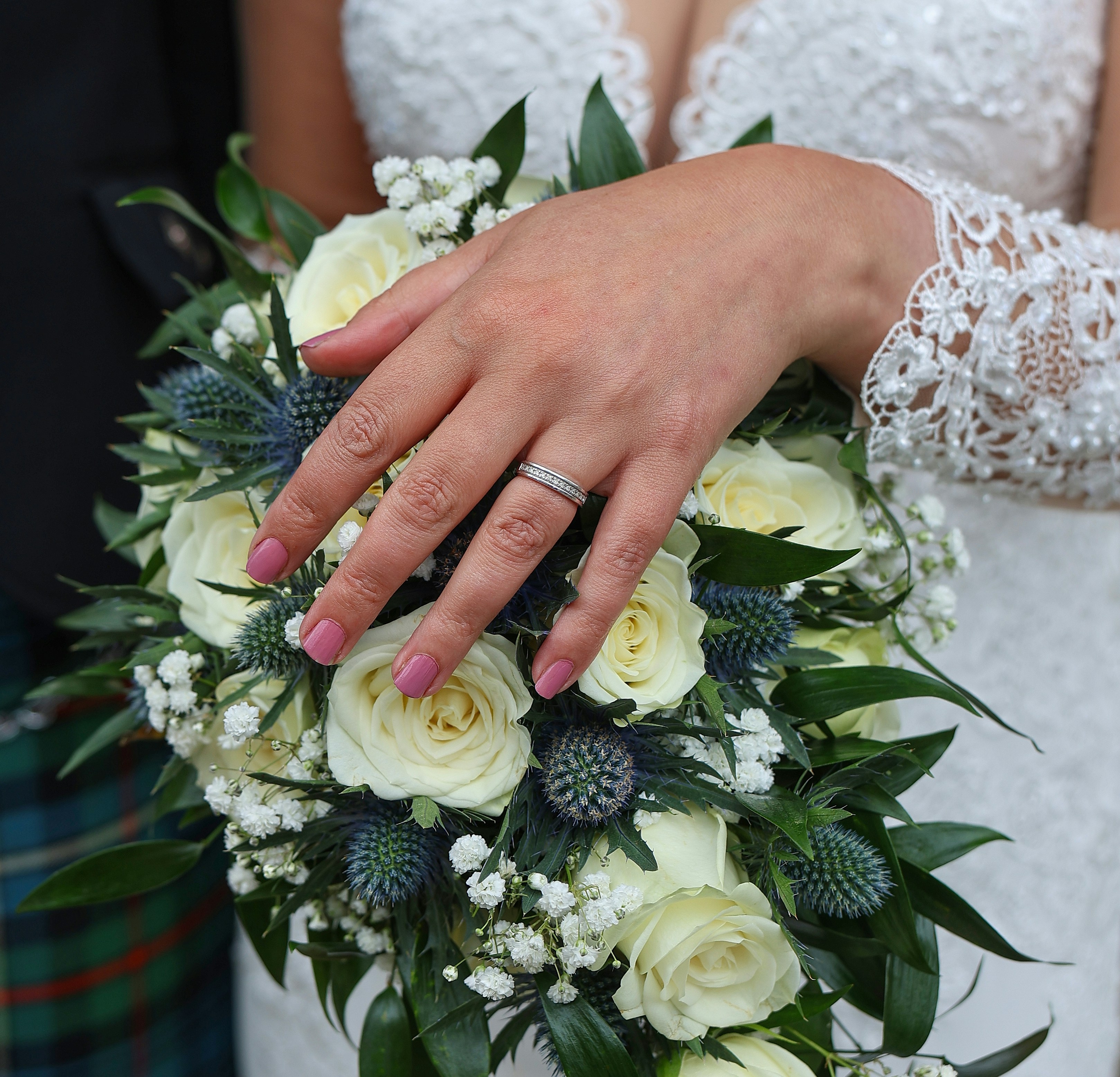 Wedding Bouquet Hand: A Clasp of White Roses and Greenery