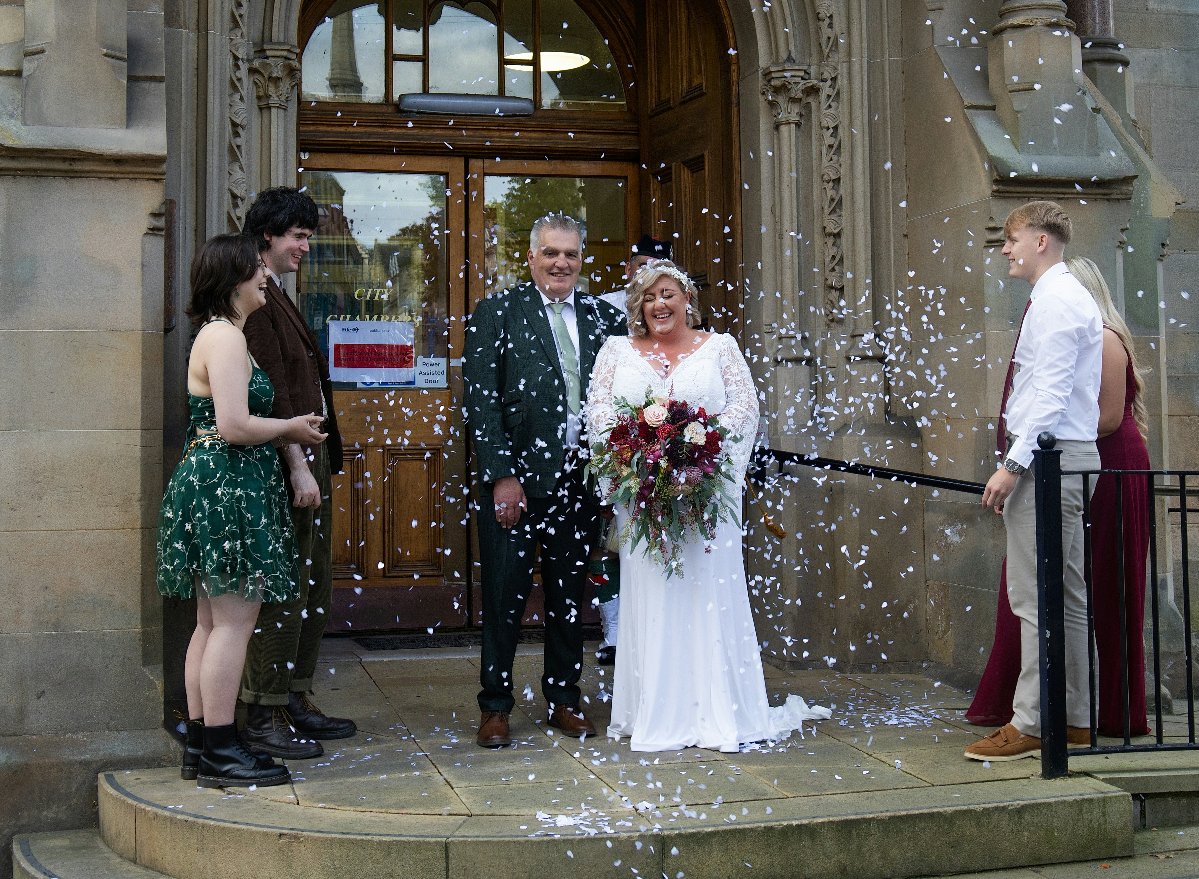 Bride and Groom Exit the Temple of Stone Amid Confetti