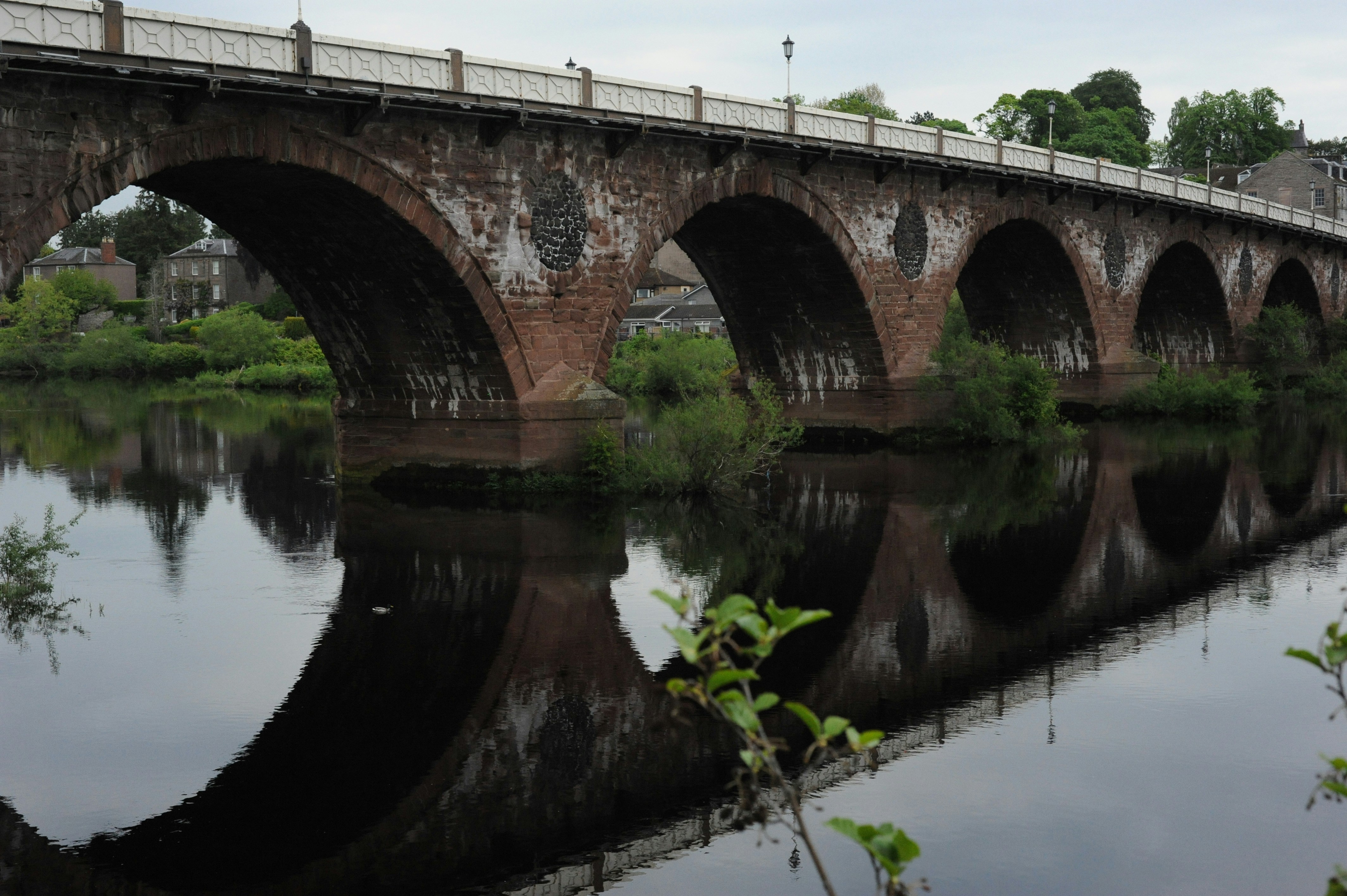 Reflected Arcades: An Ancient Bridge Across Still Waters