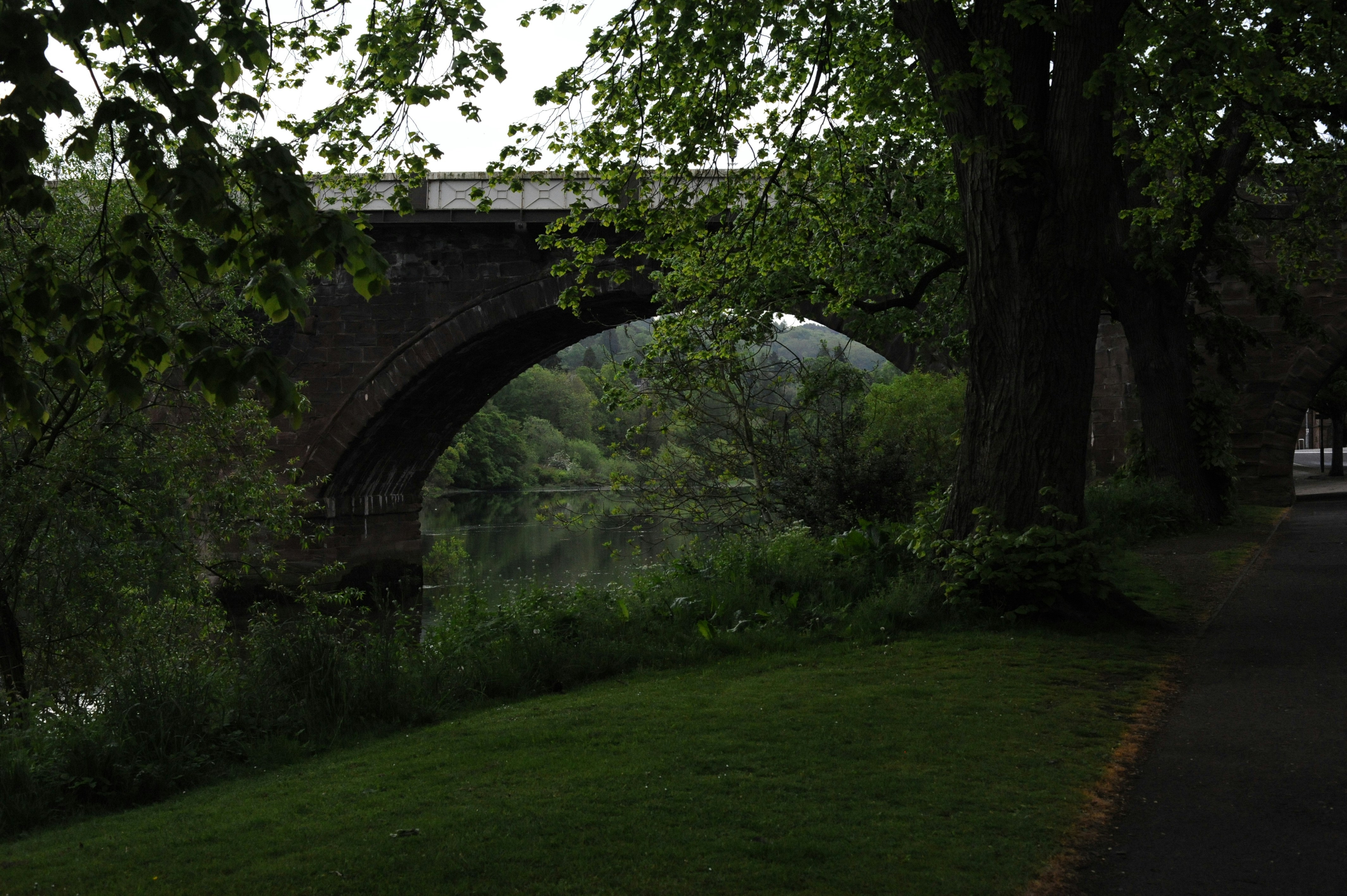 Stone Bridge Framing a Quiet Riverside Path