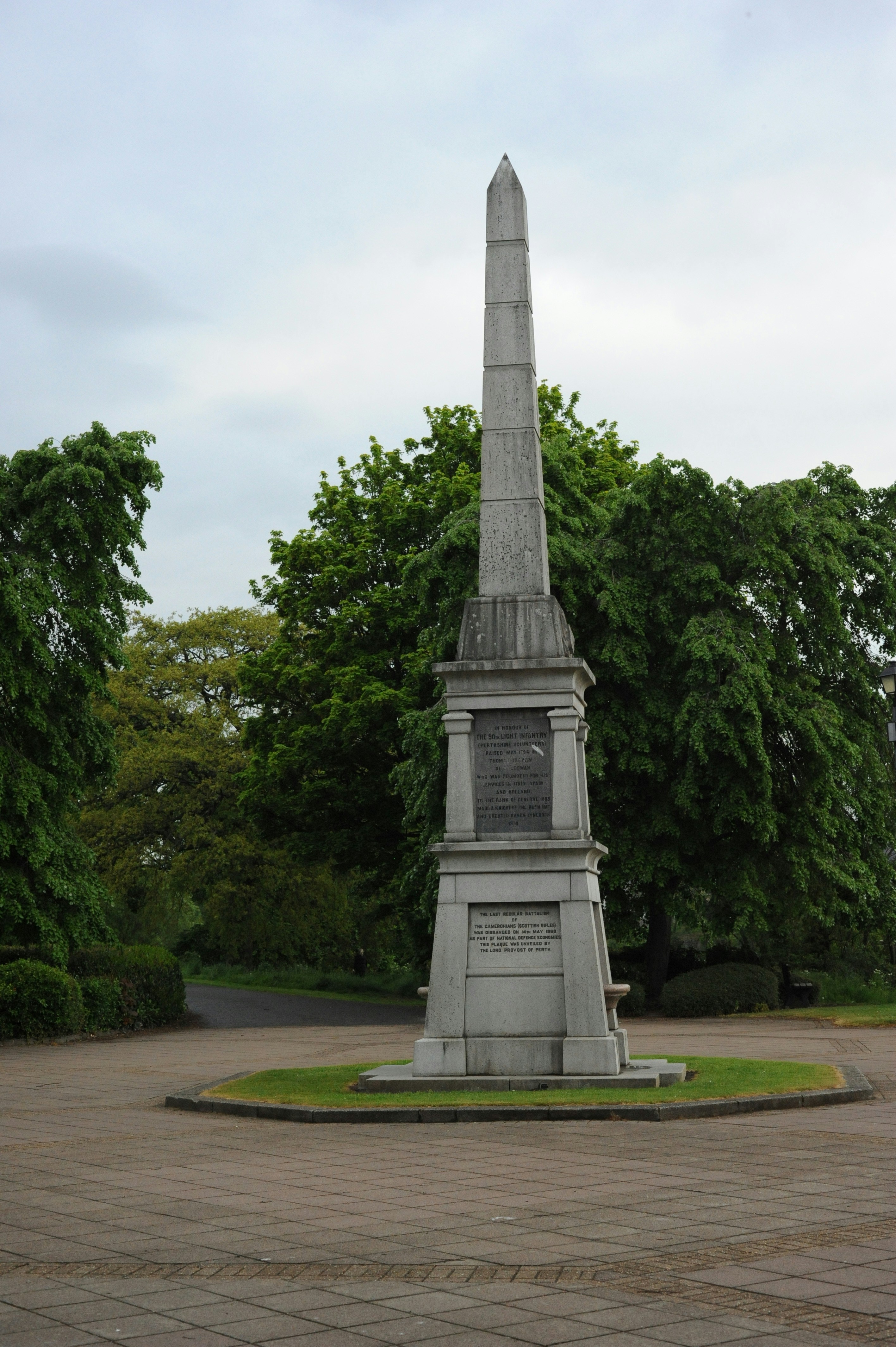 Whispering Obelisk: A Stone Beacon Rising Over Green Carved by Time