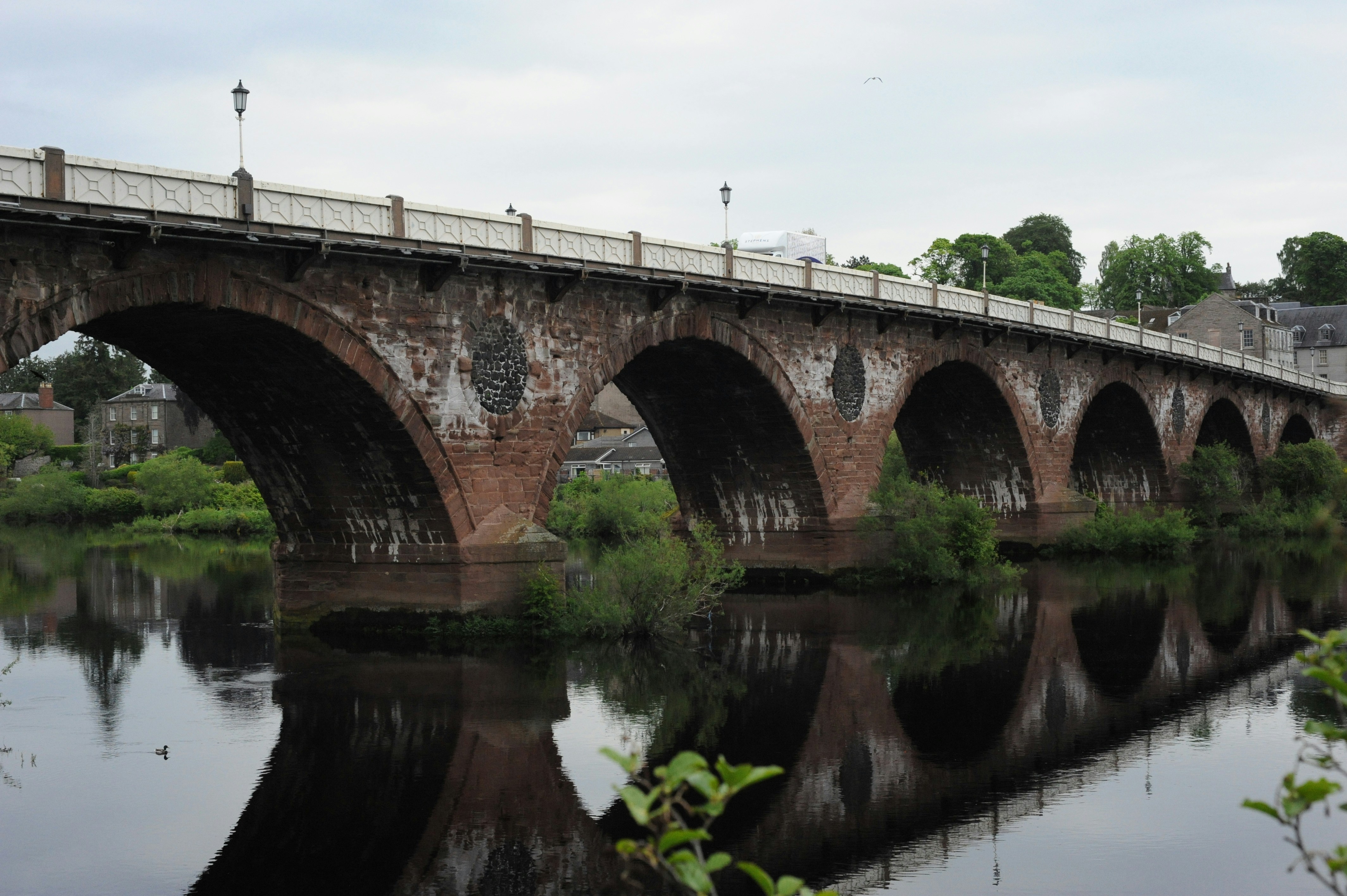 Archways Over Calm Waters: A Bridge's Echo