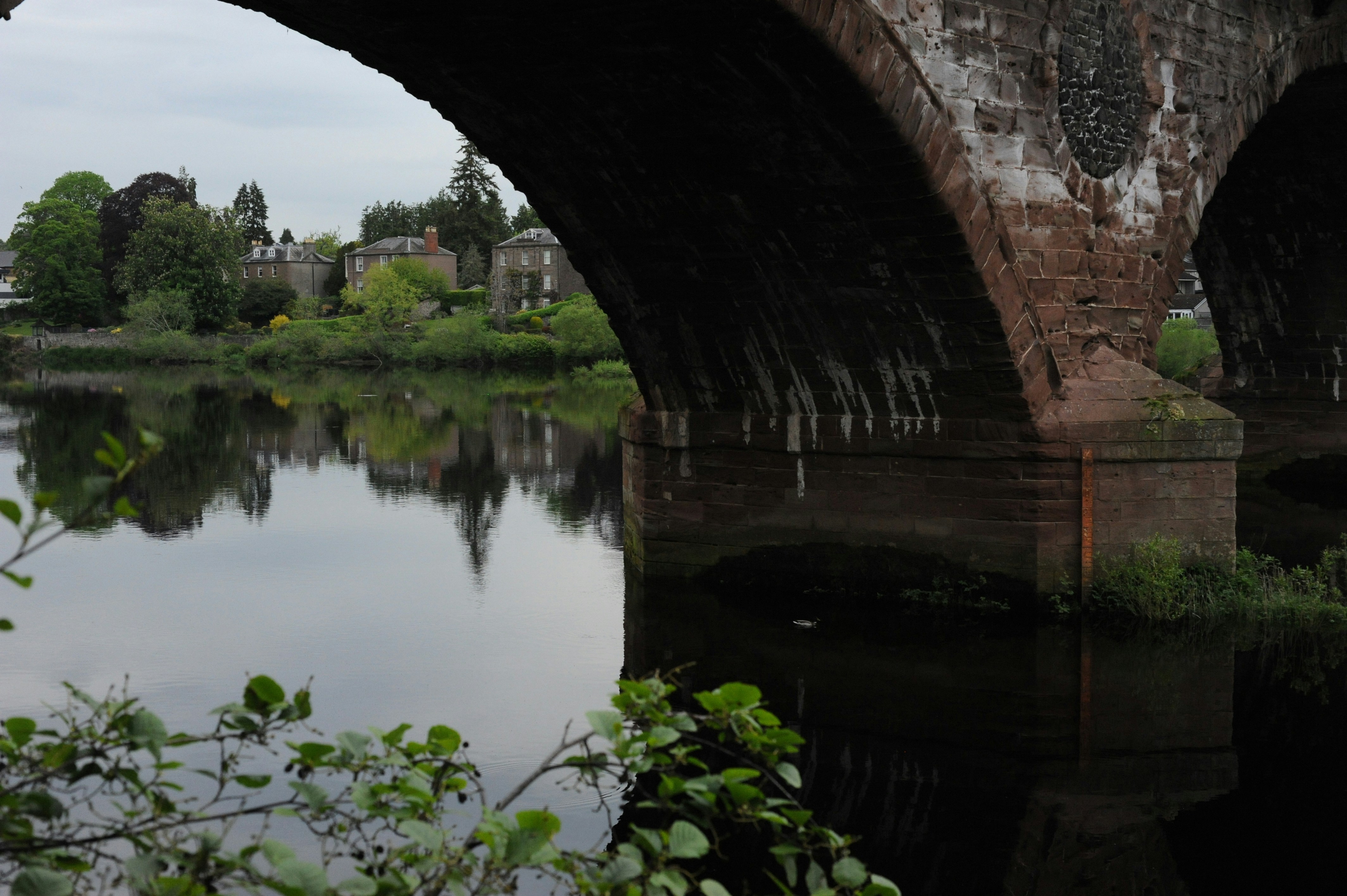 Stone Arch Over Calm Waters: A Quiet Riverside Bridge