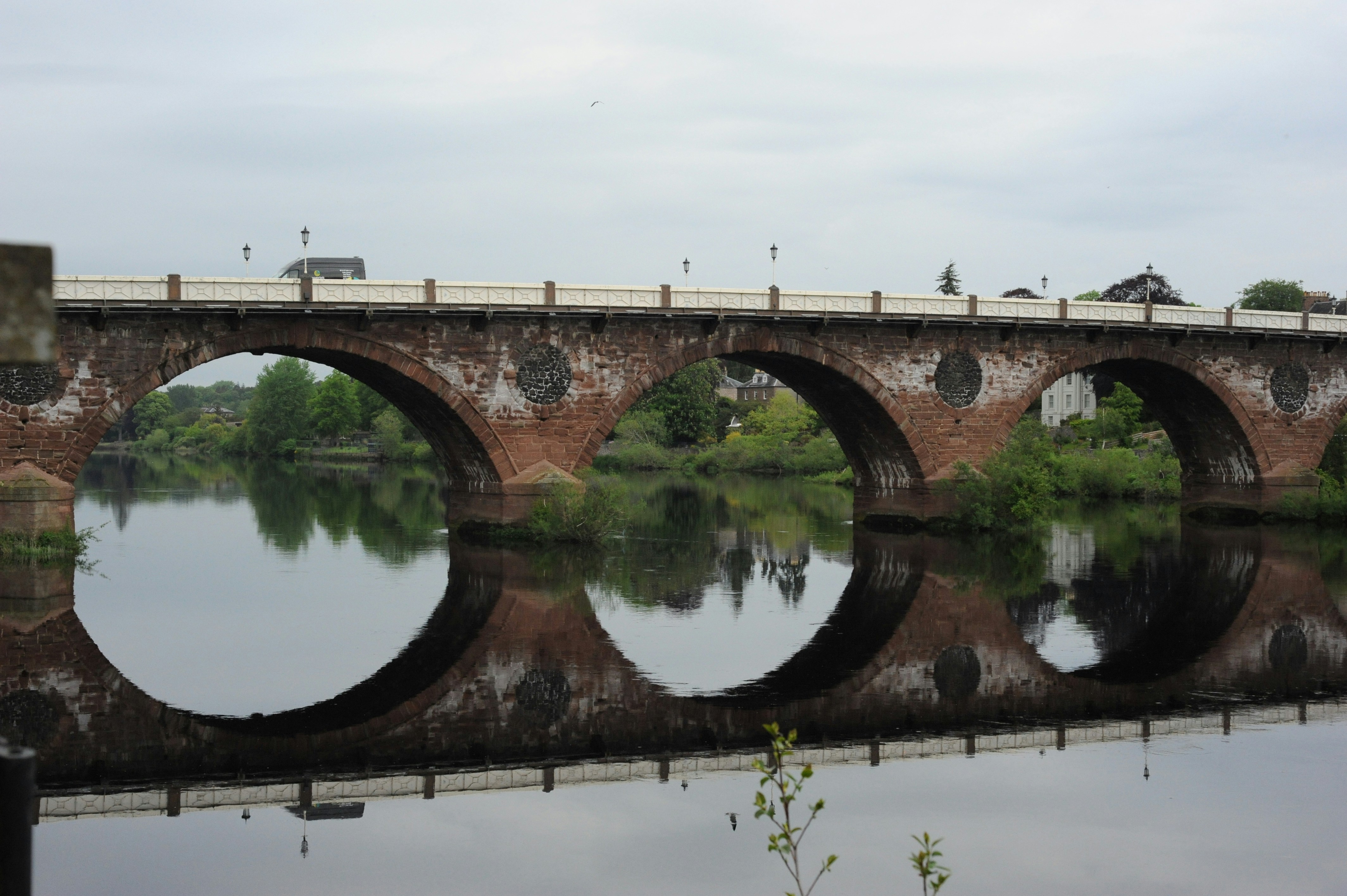 Bridge of Echoes: Circular Arches Reflected in Quiet Pool