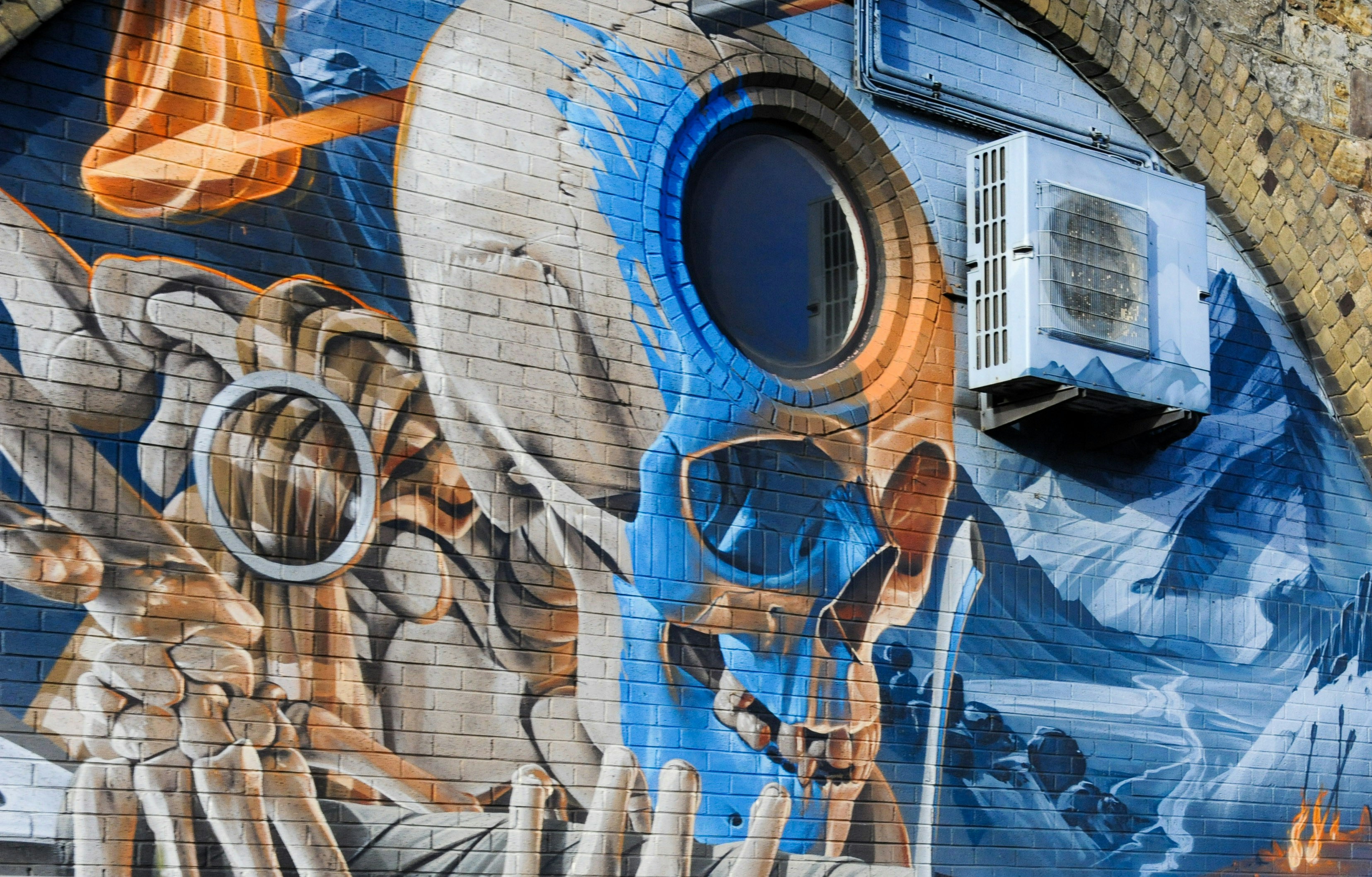 Graffiti Skull in Motion: A Painted Skull and Blue Monstrous Eye on the Brick Wall