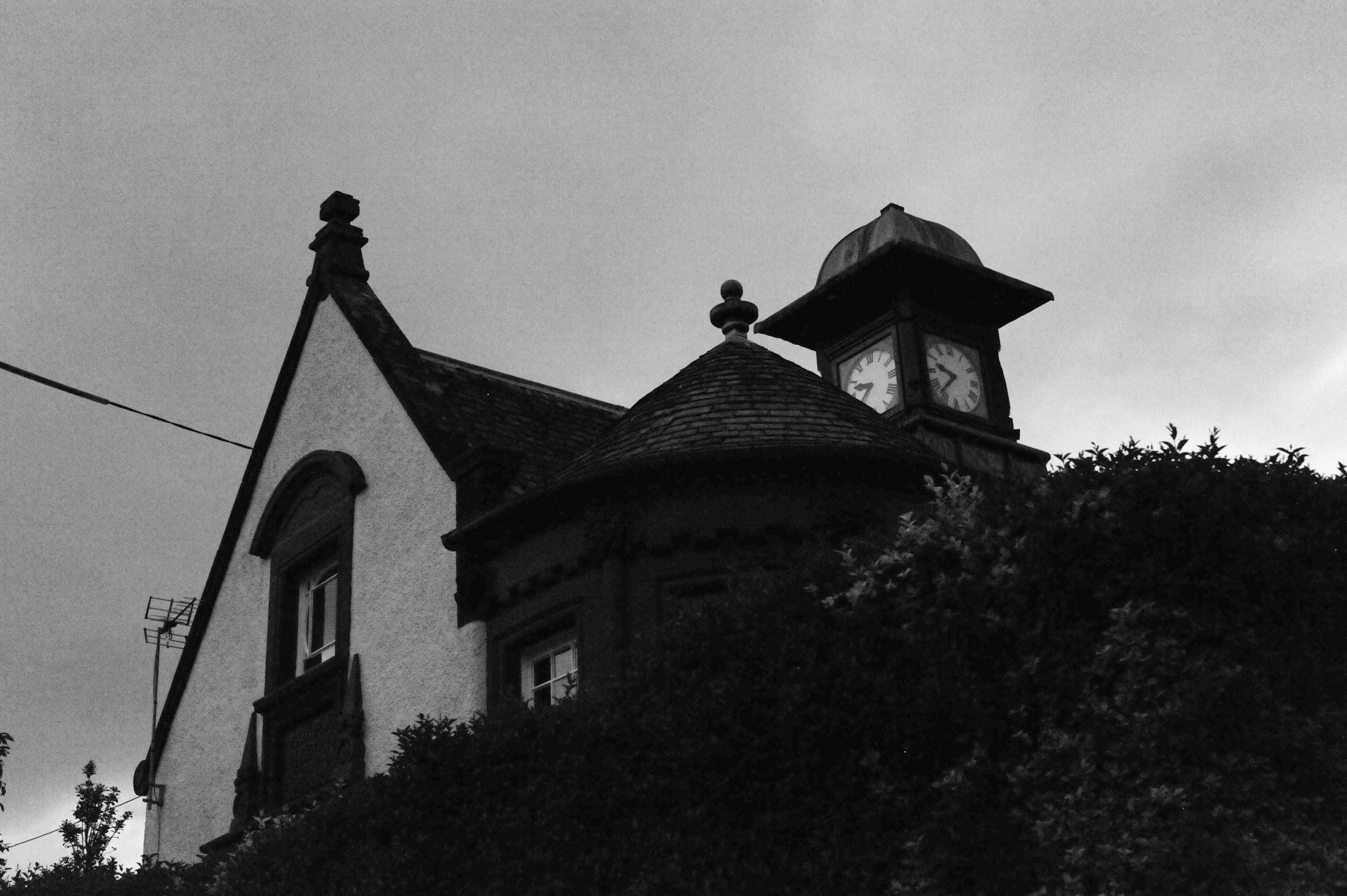 Clocktower Silhouette Overarching an Old Town Roof