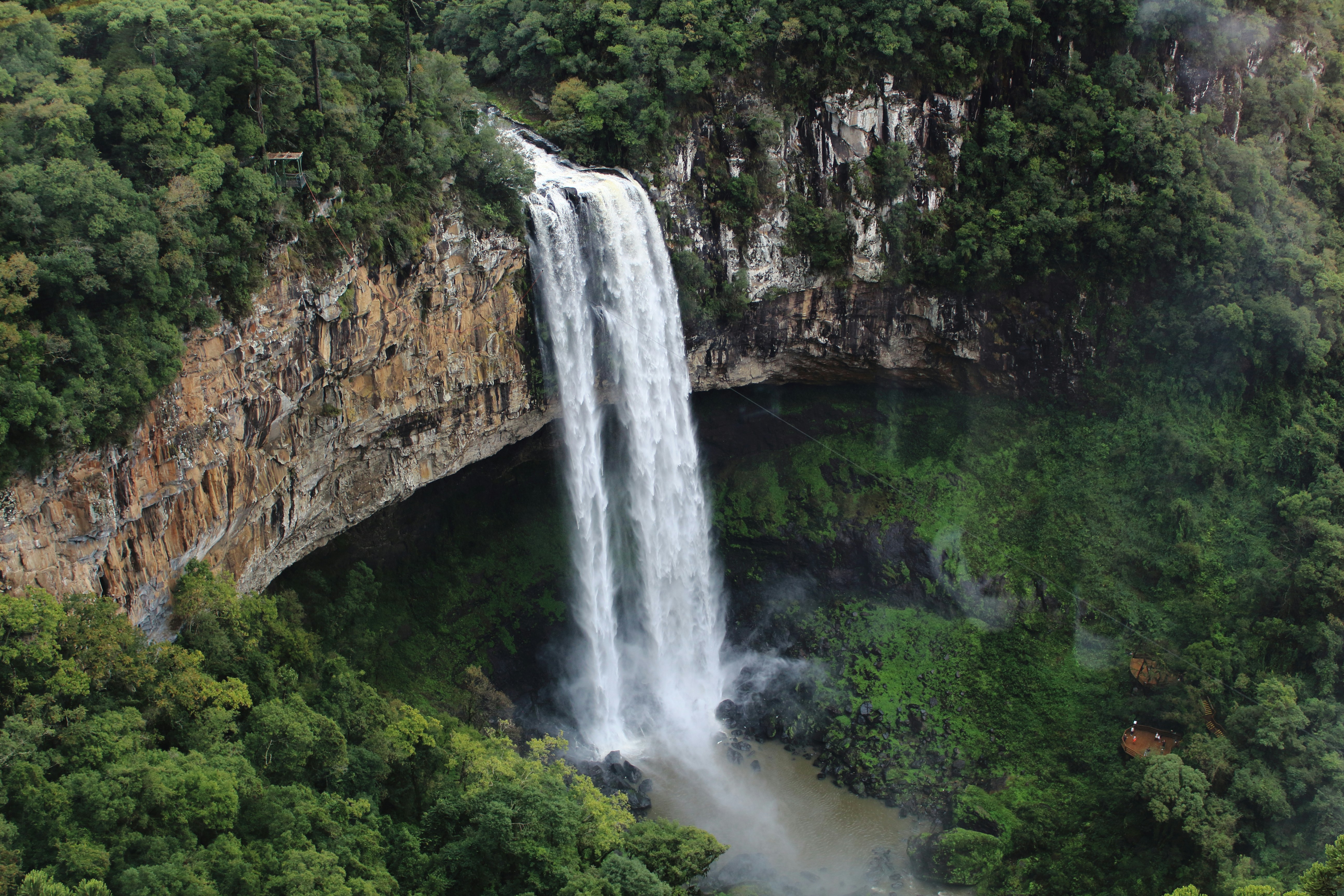 Cascading Crown: A Lush Canyon Waterfall Framed by Verdant Walls