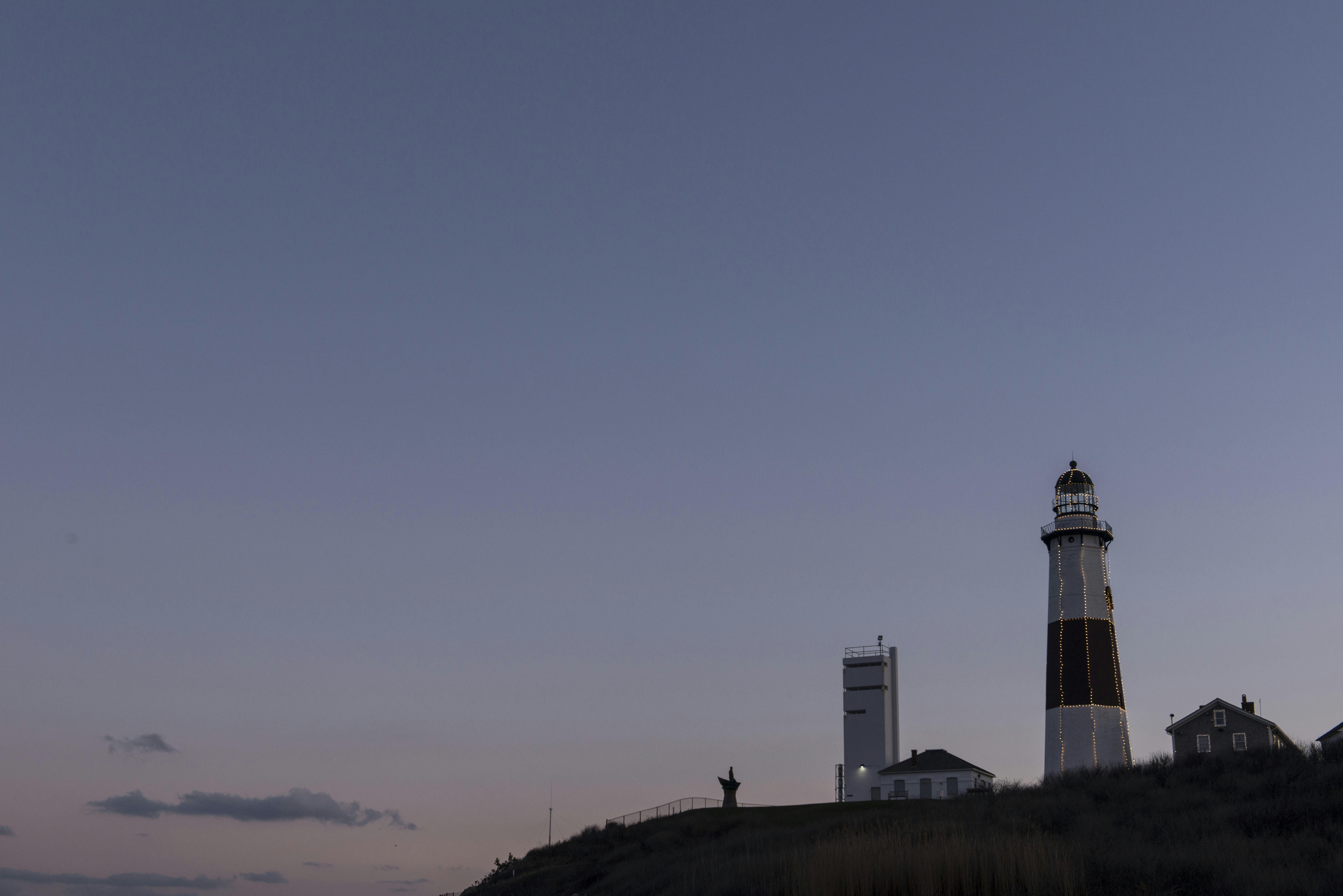 Lighthouse Sentinel at Dusk: A Coastline Silhouette