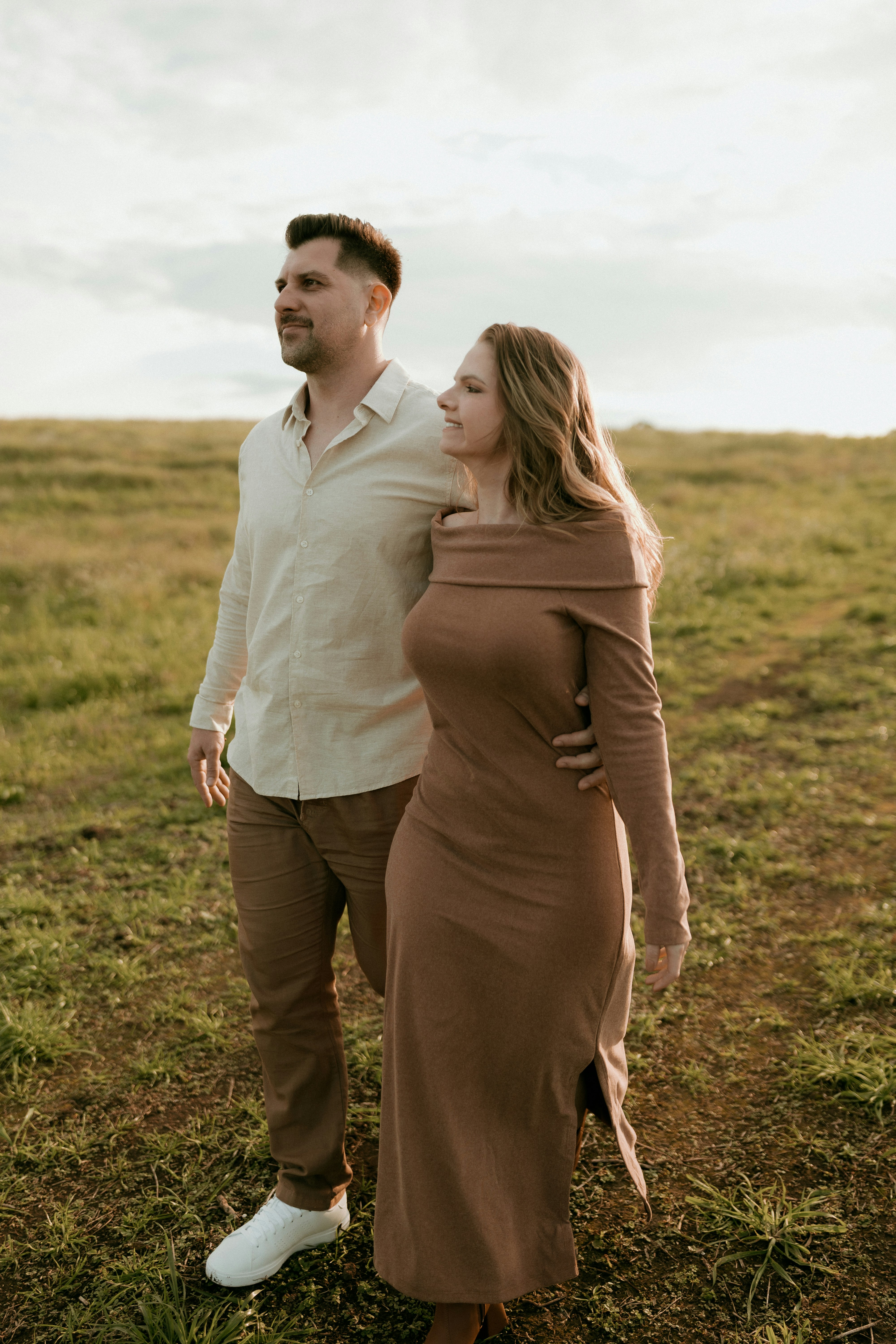 Couple Walking Together Across a Sunlit Field