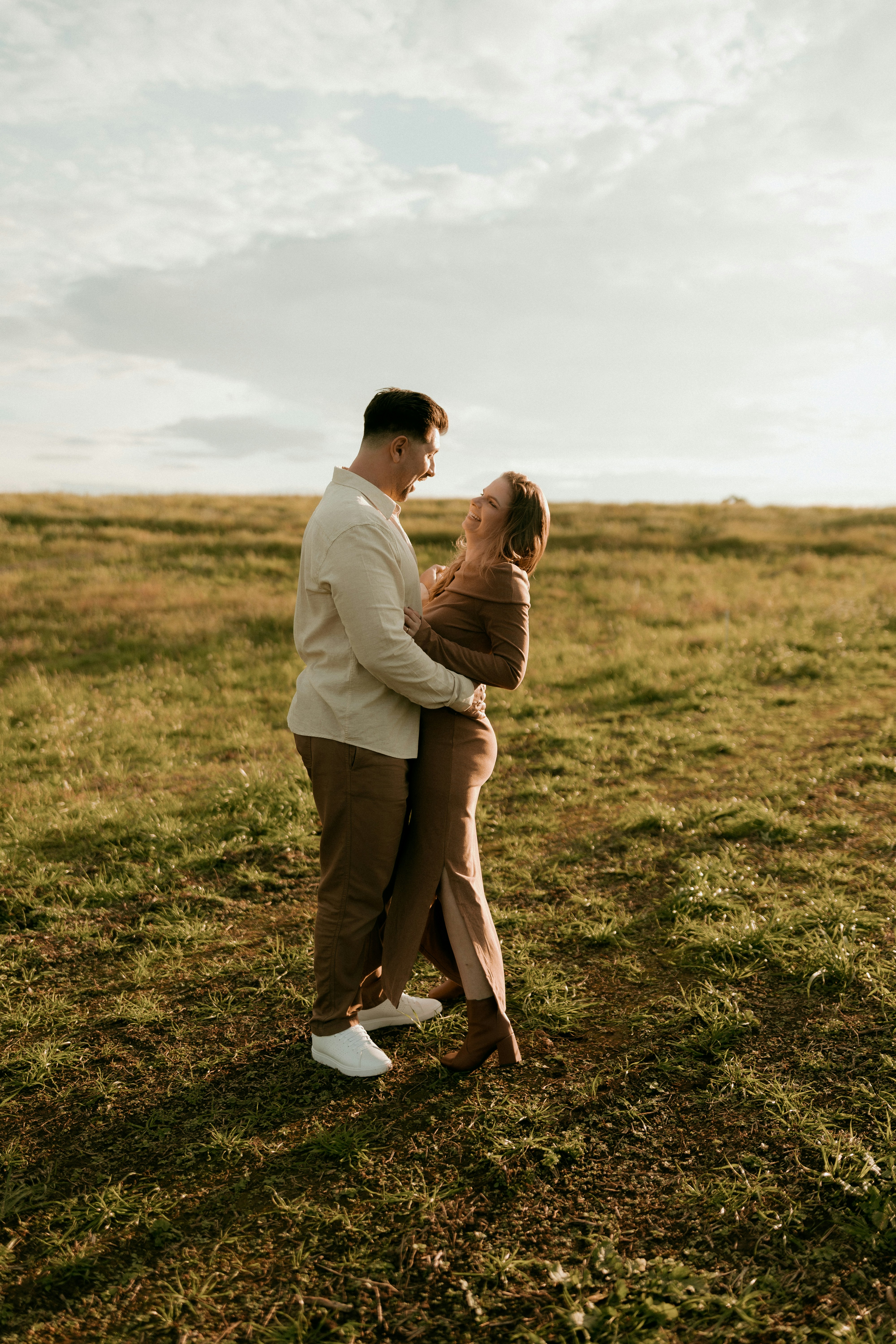 Embrace at Golden Hour: A Quiet Connection in the Open Field