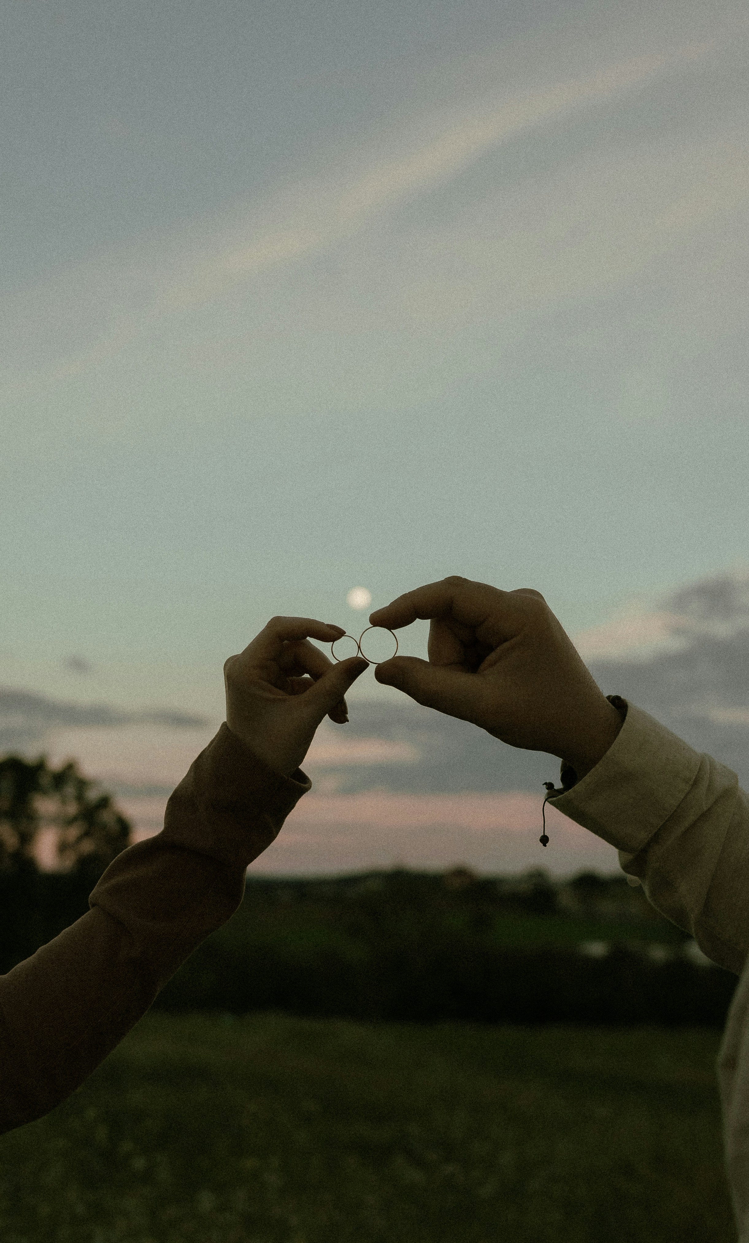 Two Hands, One Ring: A Moment of Connection Amid Sunset