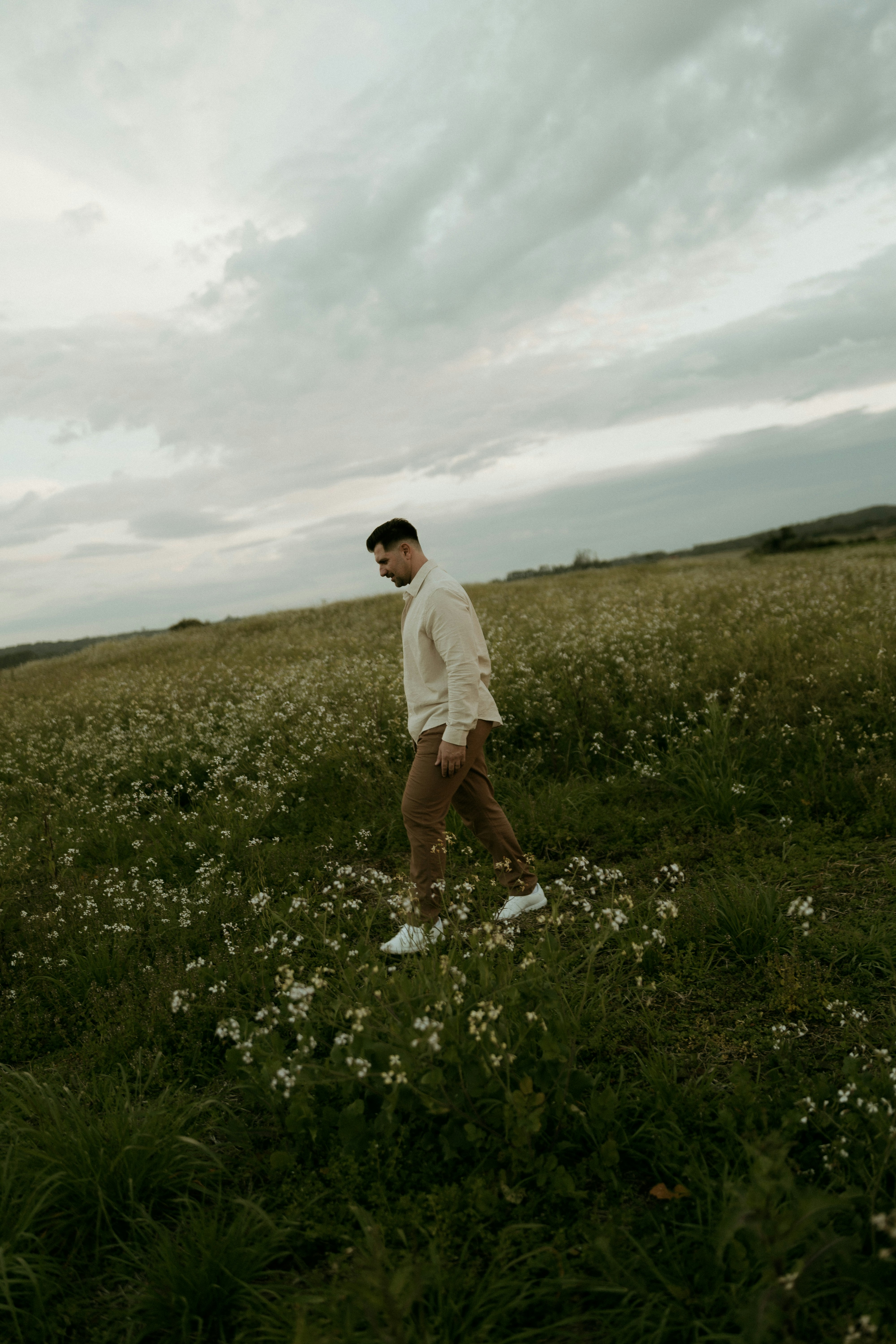Solitary Walk Through a Field of White Blooms at Dusk