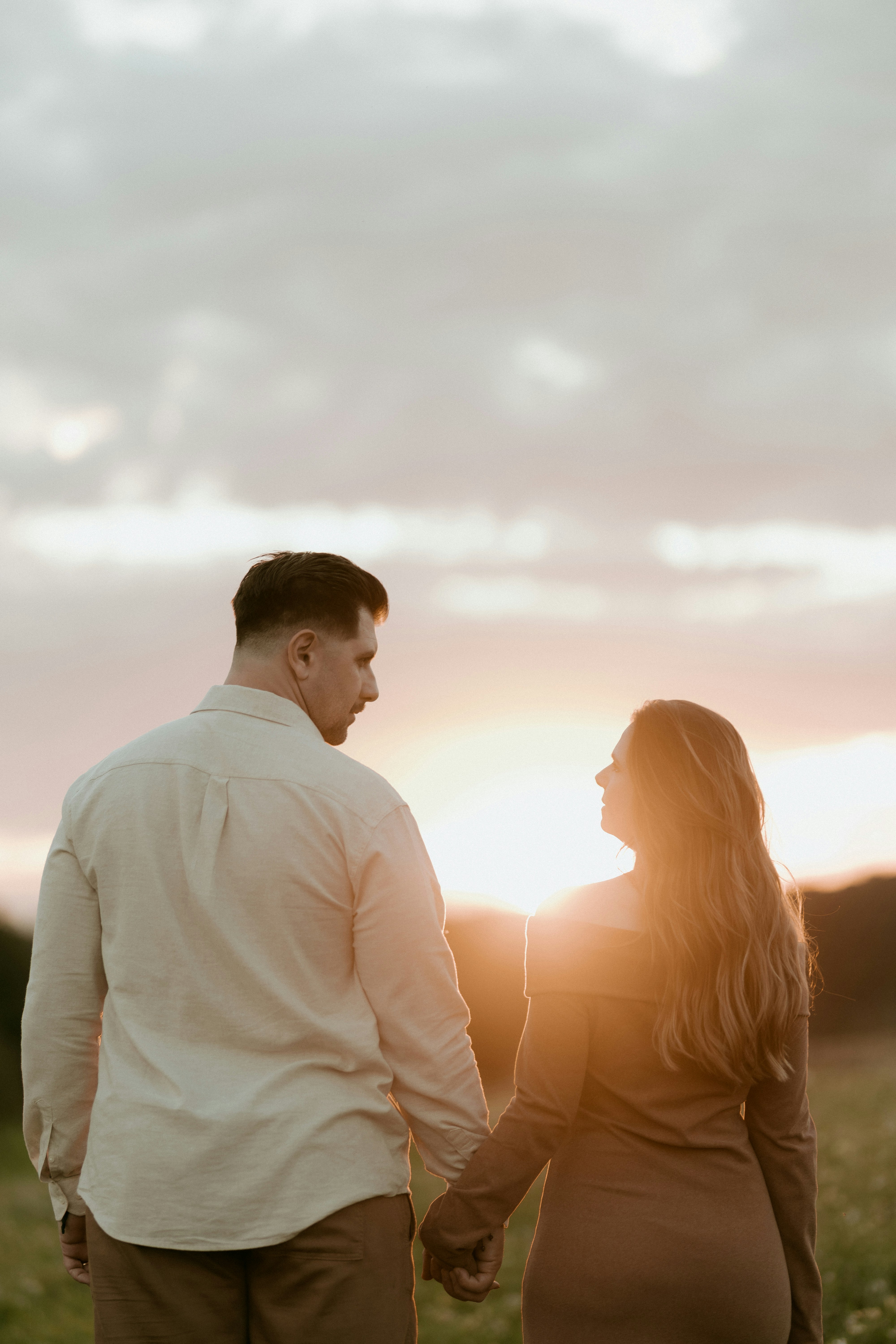Sunset Promise: A Couple Walks Hand in Hand into Golden Light