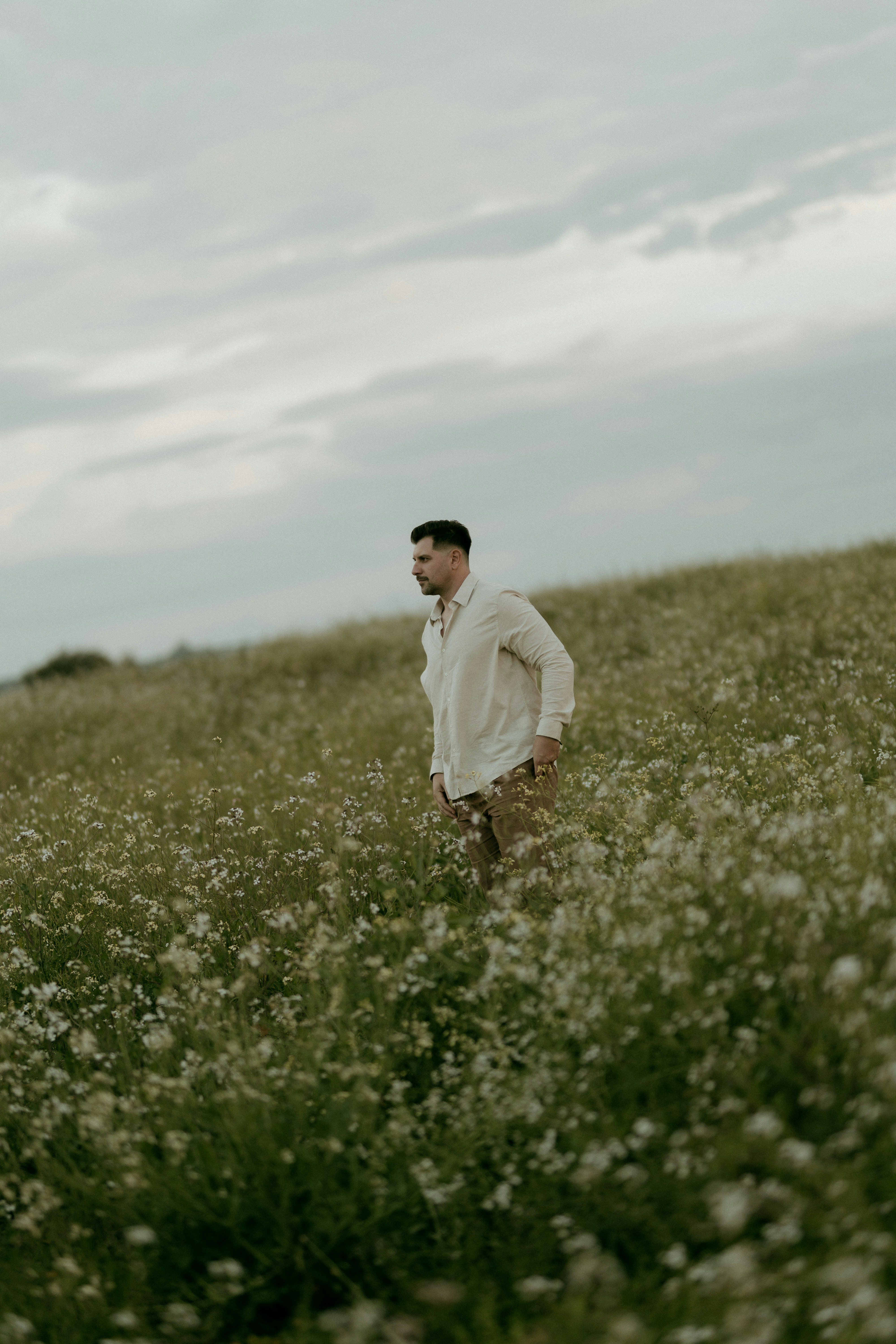 Lone Traveler in a Field of White Blooms