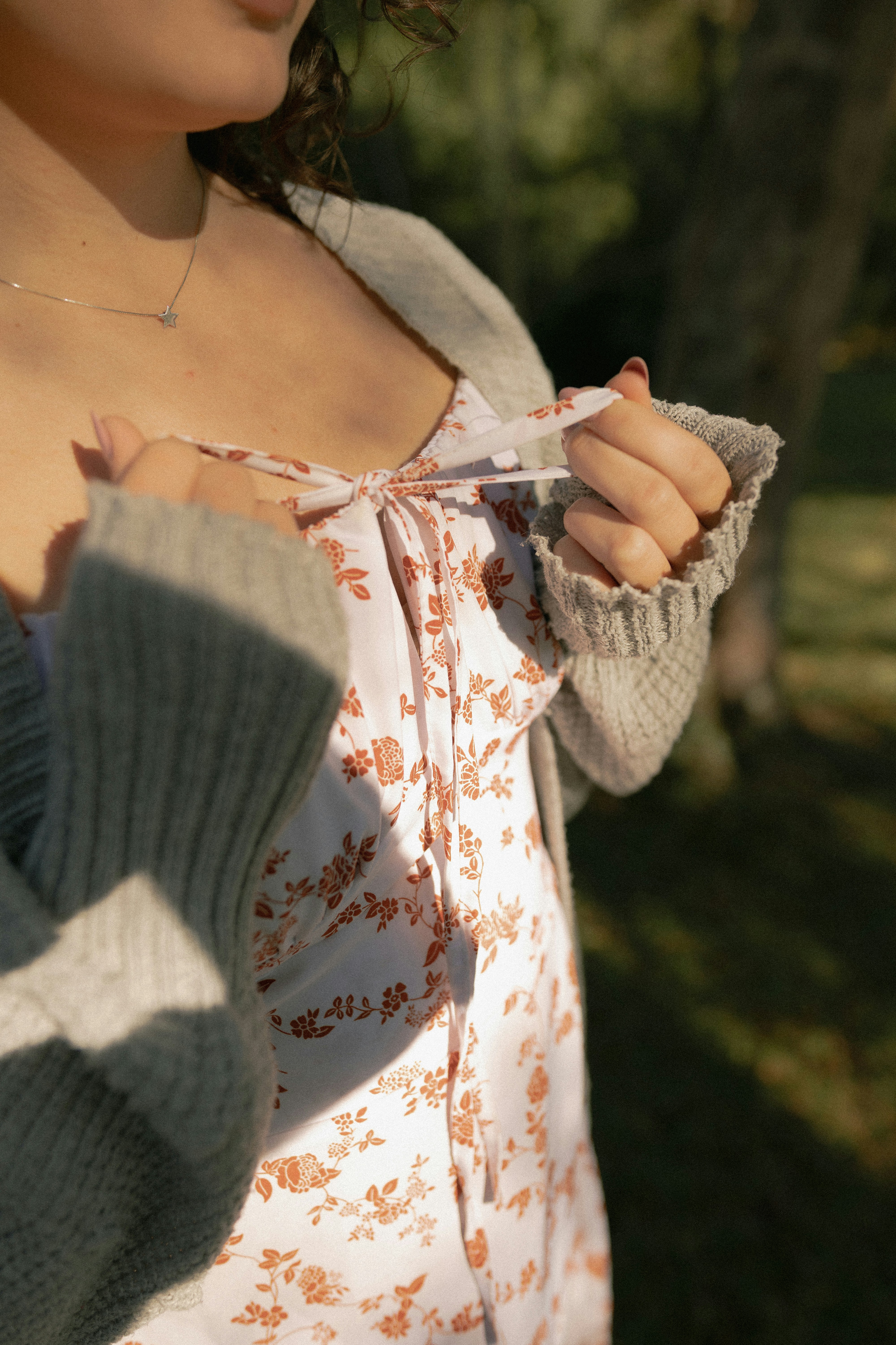 Close-up of Floral Tie Detail and Knit Cardigan