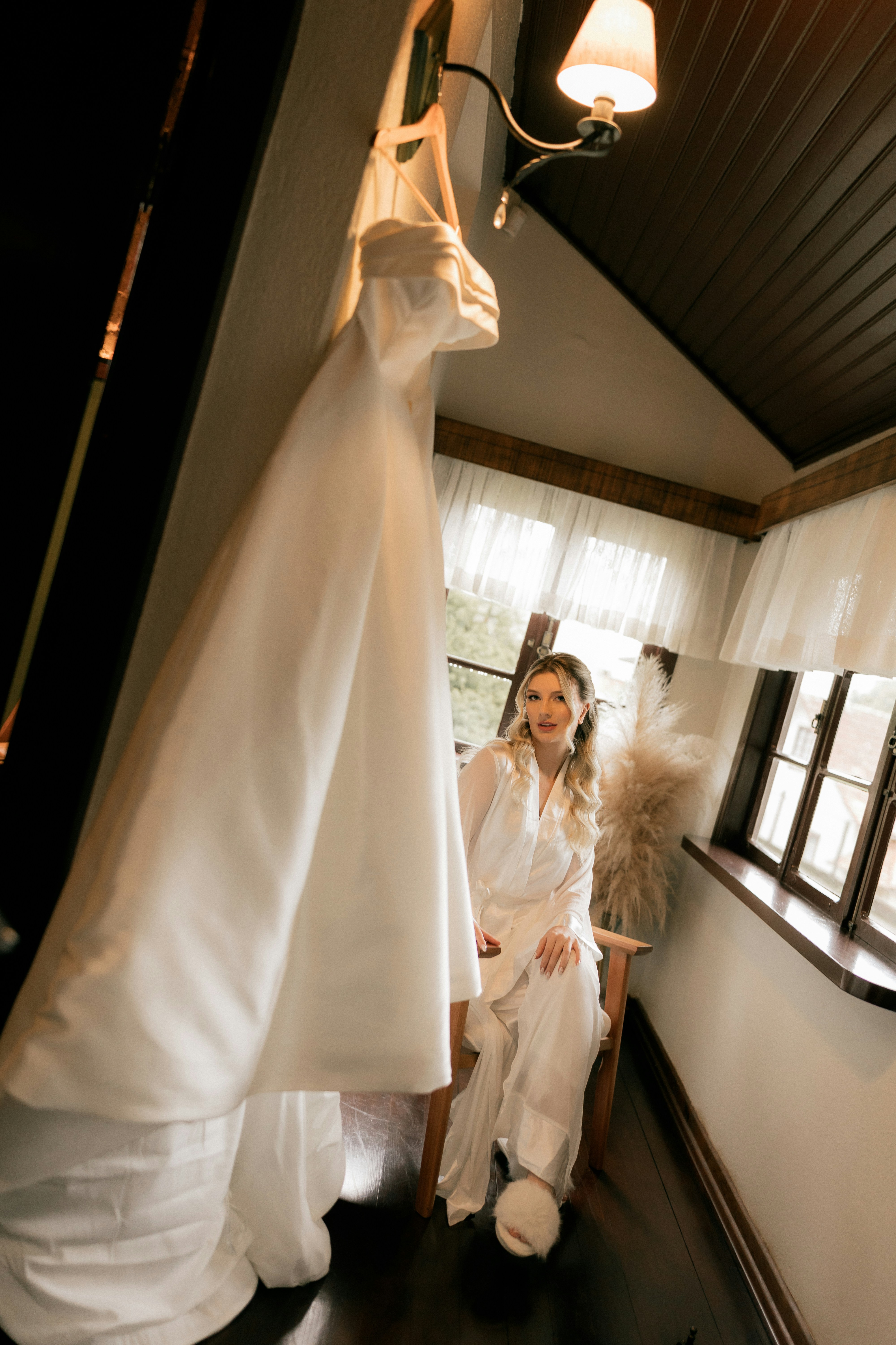 Bride-to-be in a sunlit alcove: white gown and playful slippers