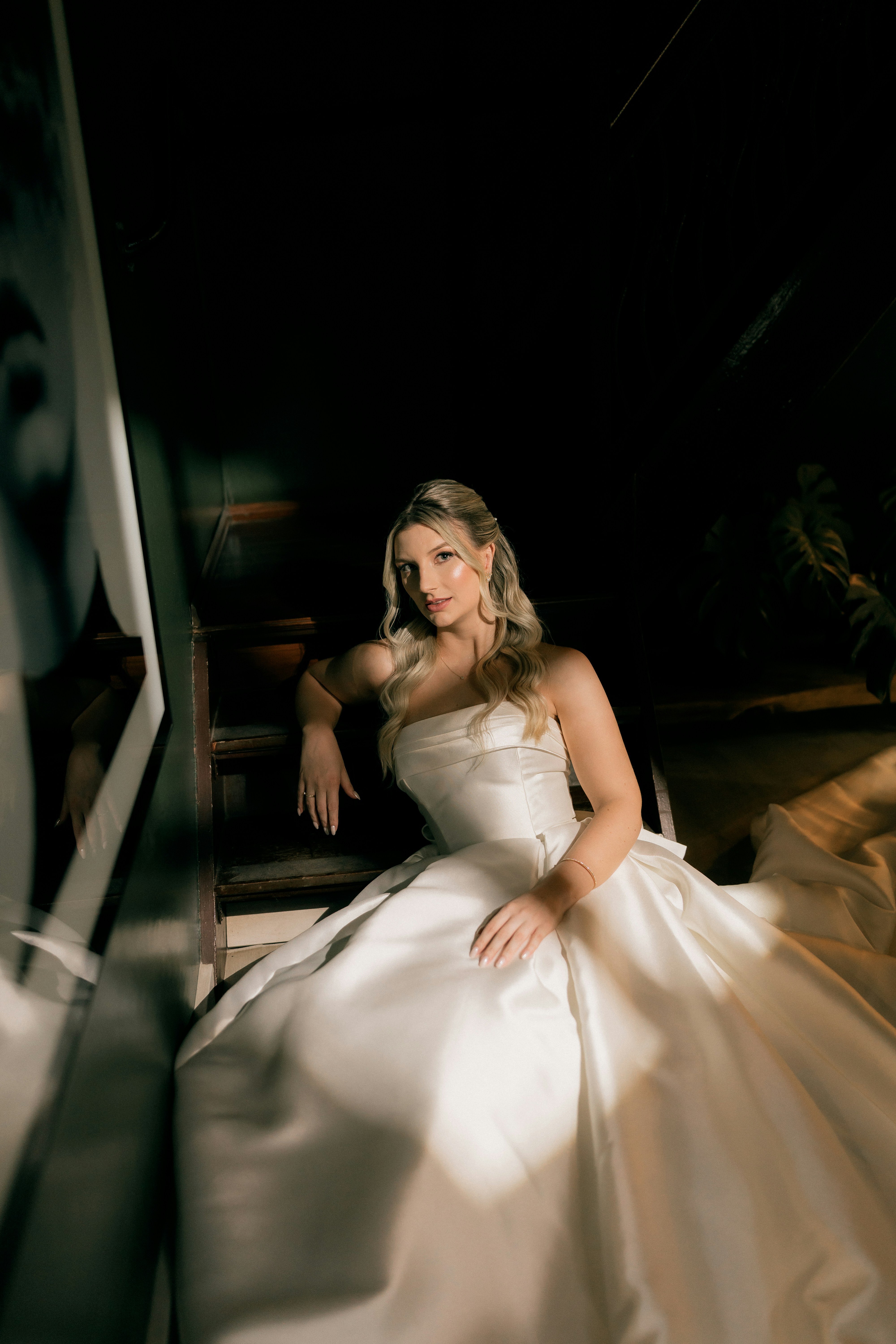 Bride on the Stairs: A Quiet Moment in Silk and Shadow