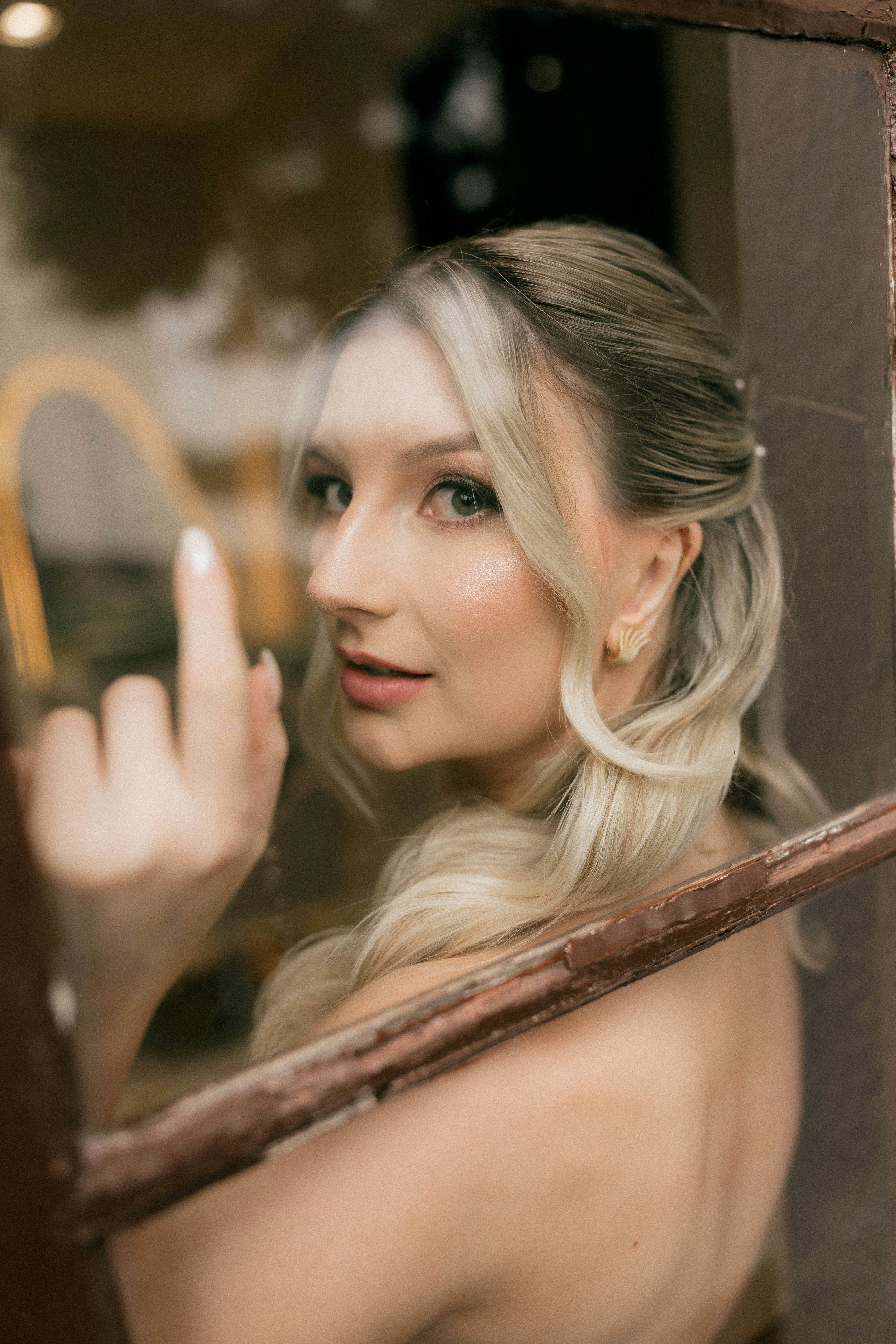 Soft Reflection: A Portrait framed by Glass and Glow