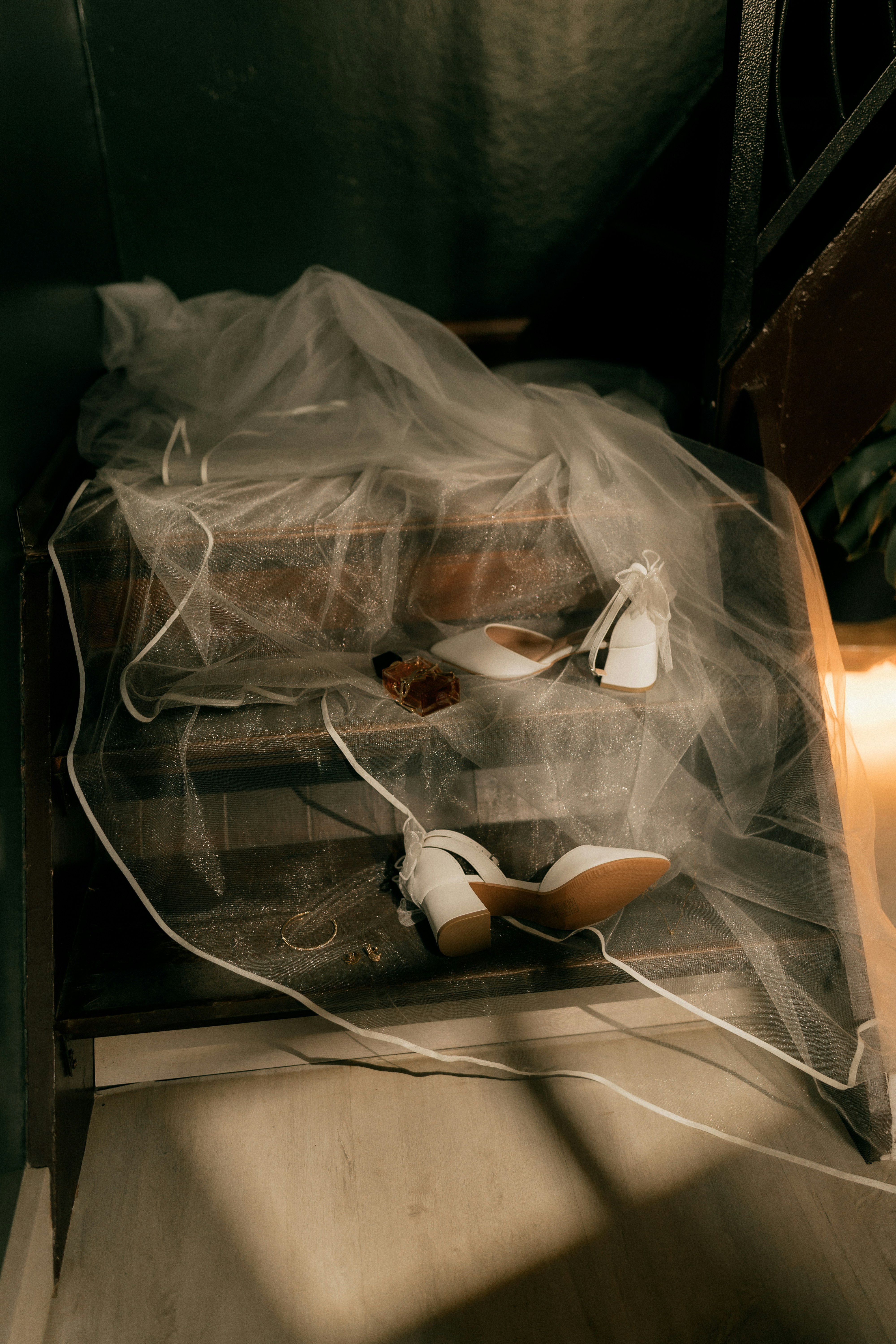 Veiled Staircase: White Heels Under Delicate Netting