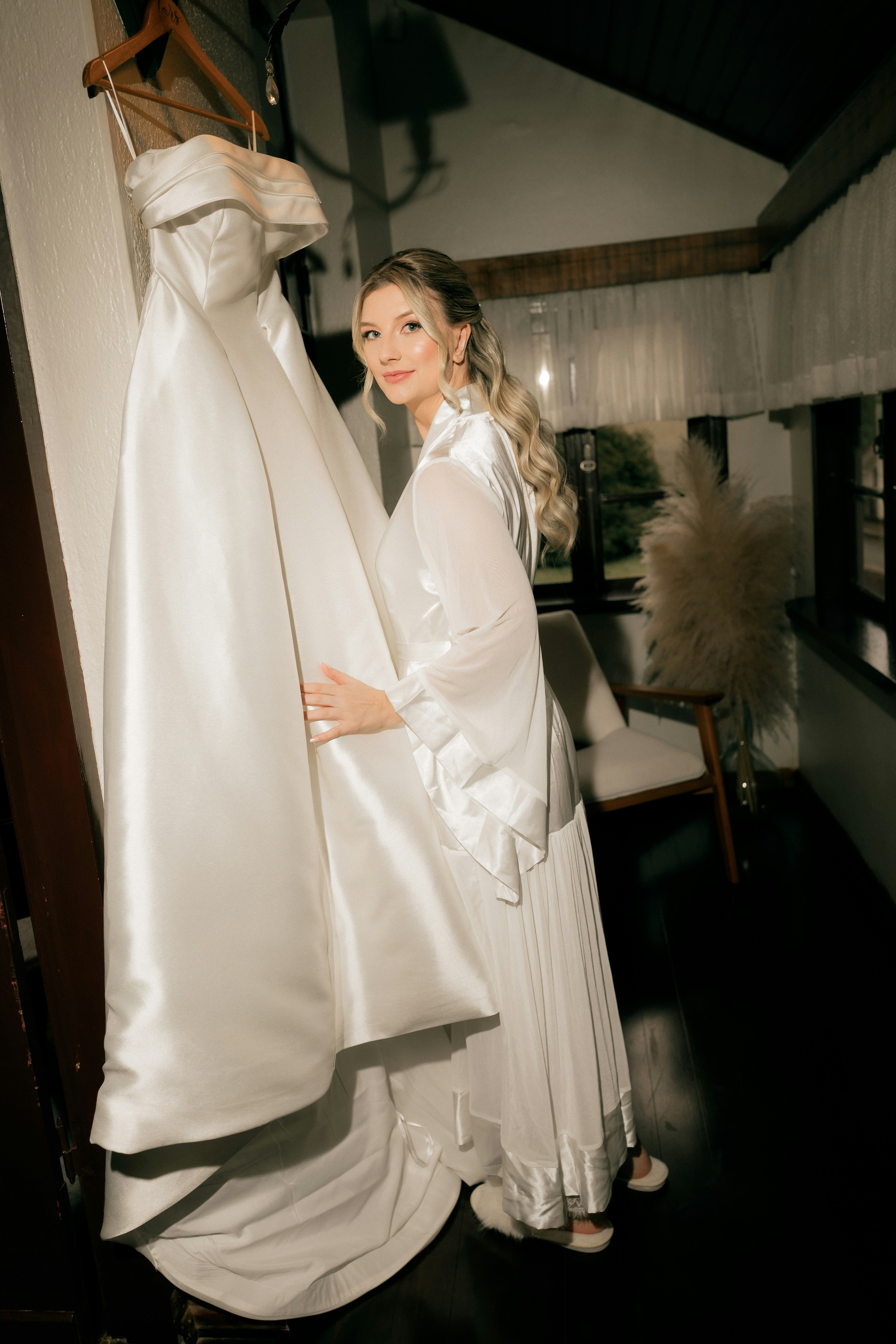 Quiet Radiance: Bride in Satin at the Velvet Curtain