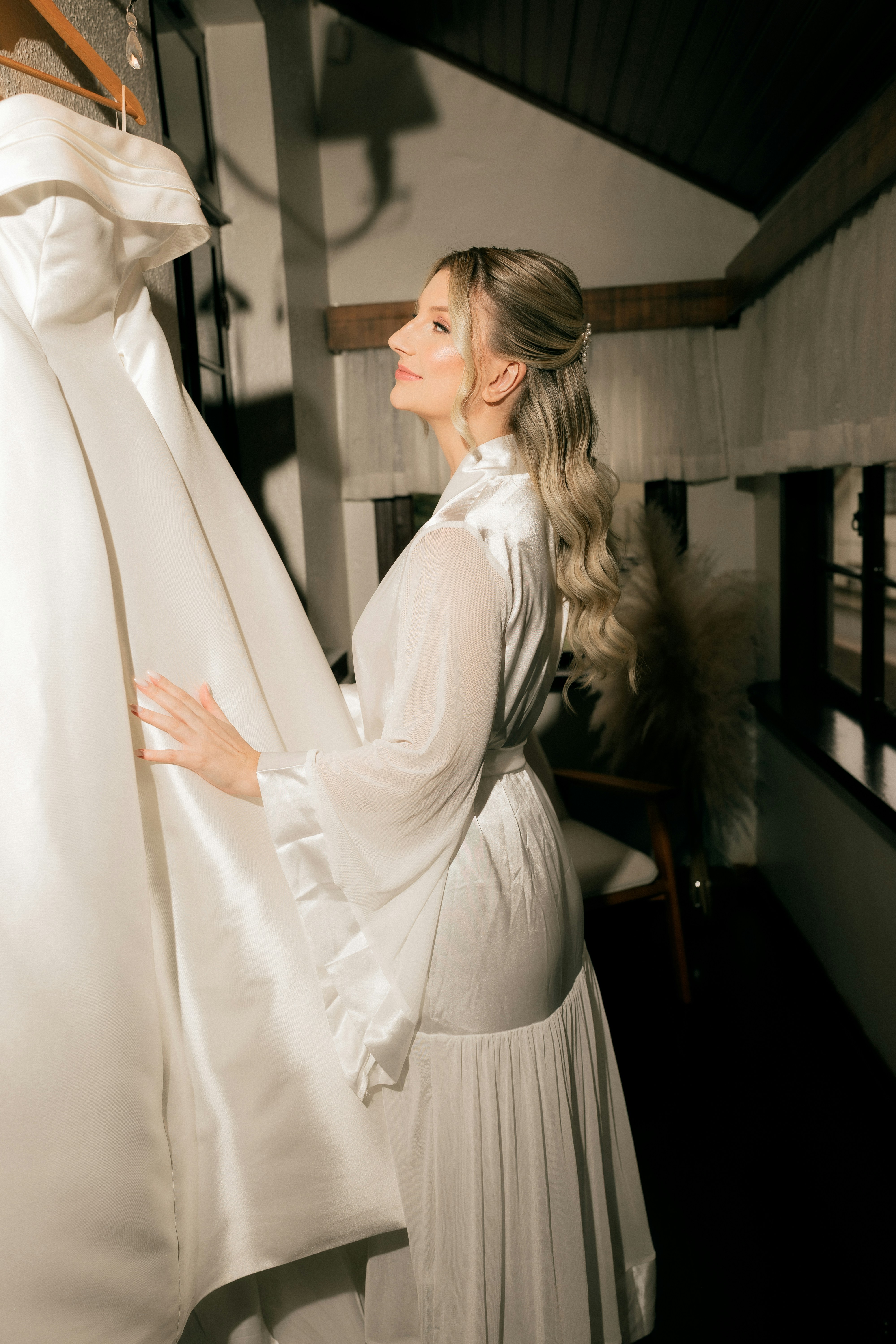 Elegance in Satin: Bride-to-be in a Quiet Dressing Room