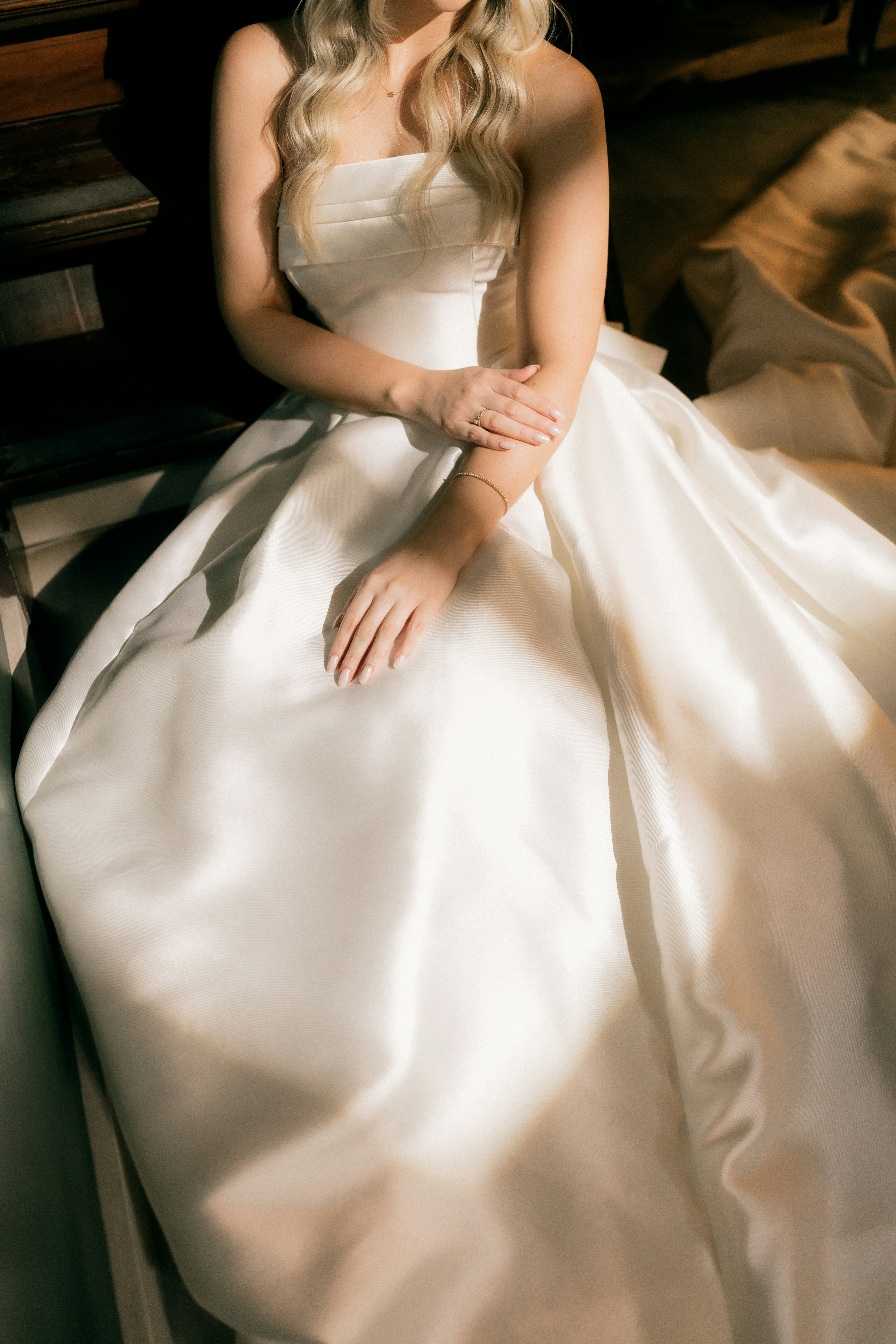 Elegance in Linen: A Bride Solemnly Poised on Velvet Steps
