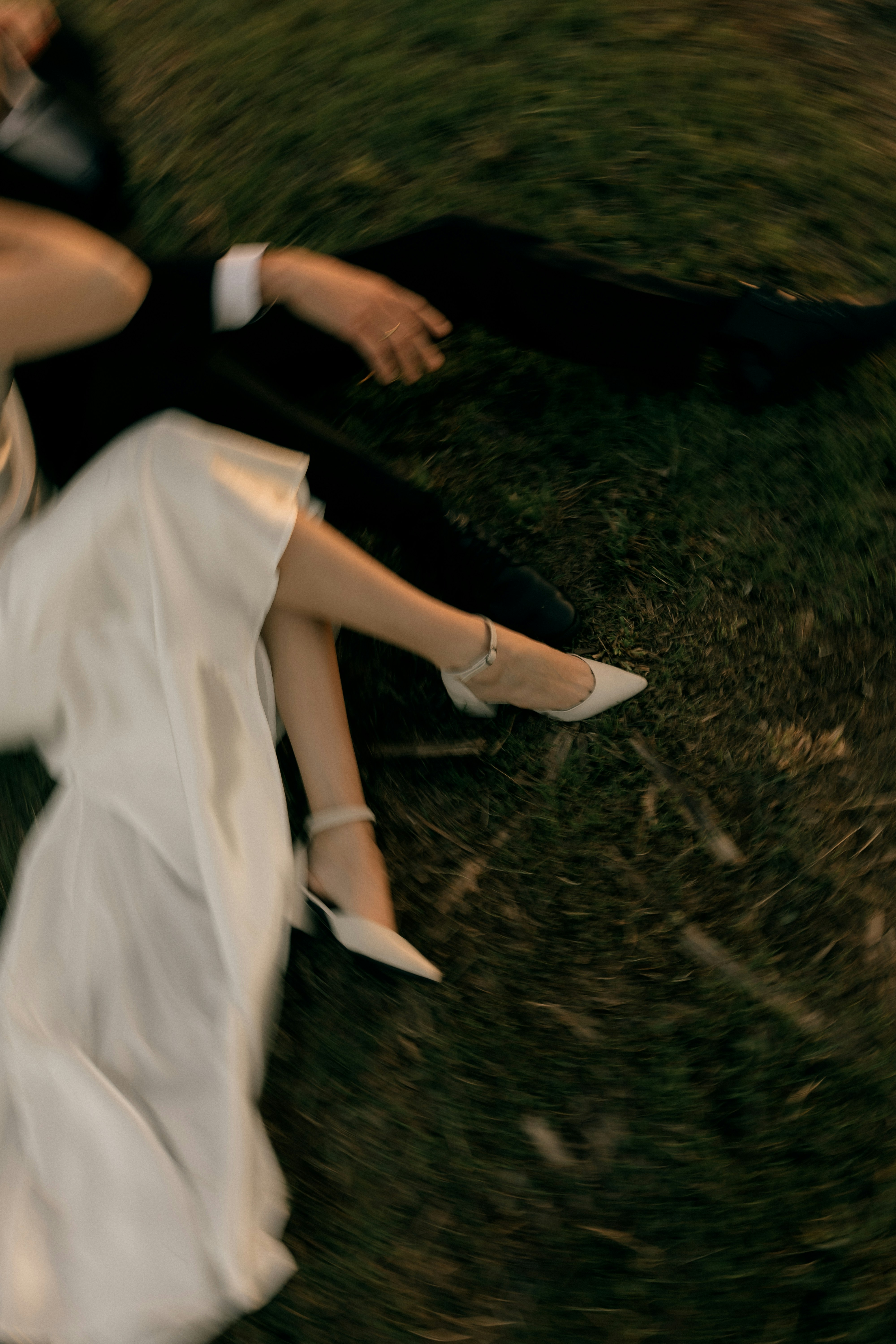 Veiled Elegance: Blurred Motion of a Duo in Evening Attire