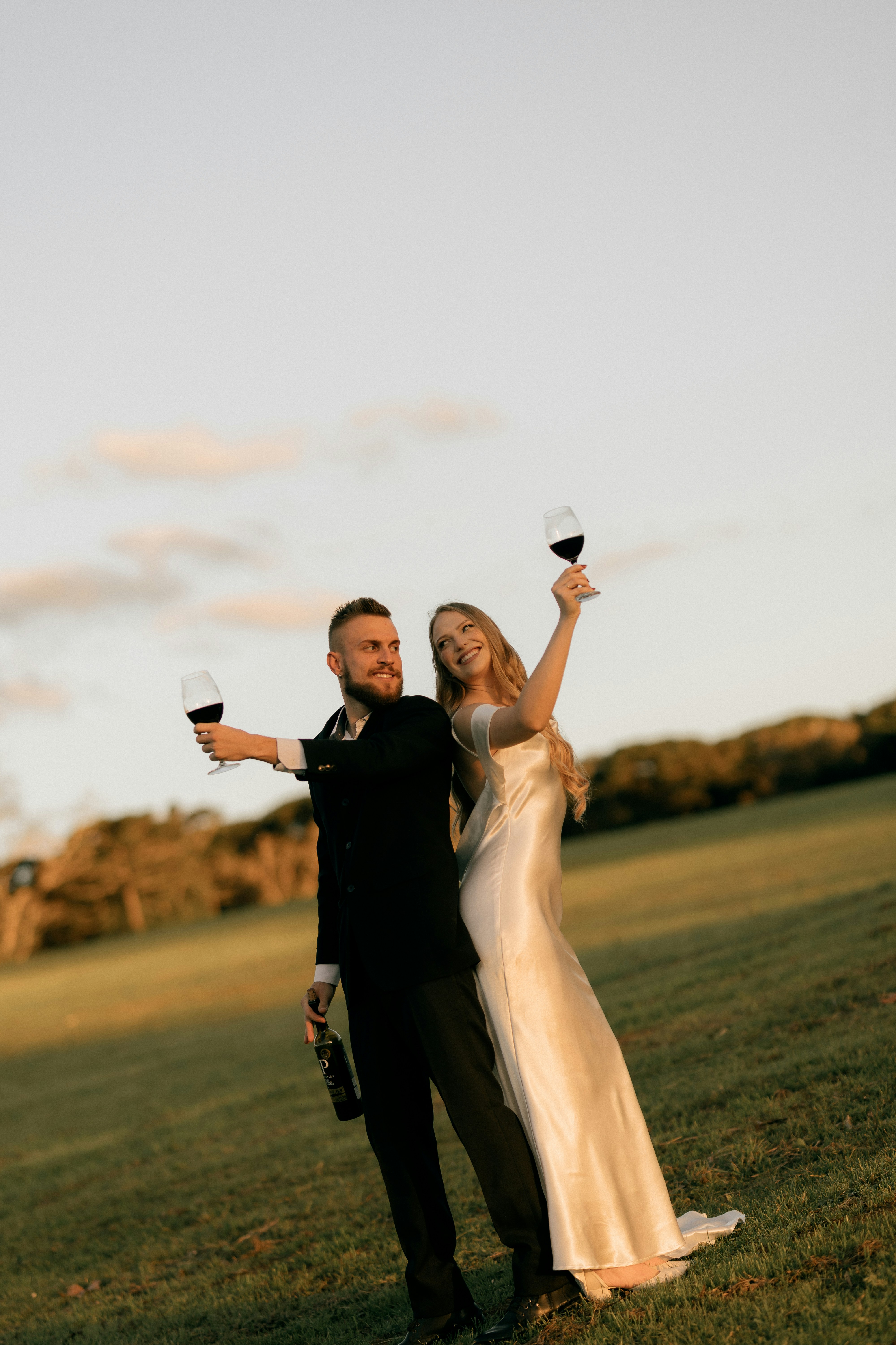 Toast in Twilight: A Couple Cheers with Wine on a Sundrenched Hill