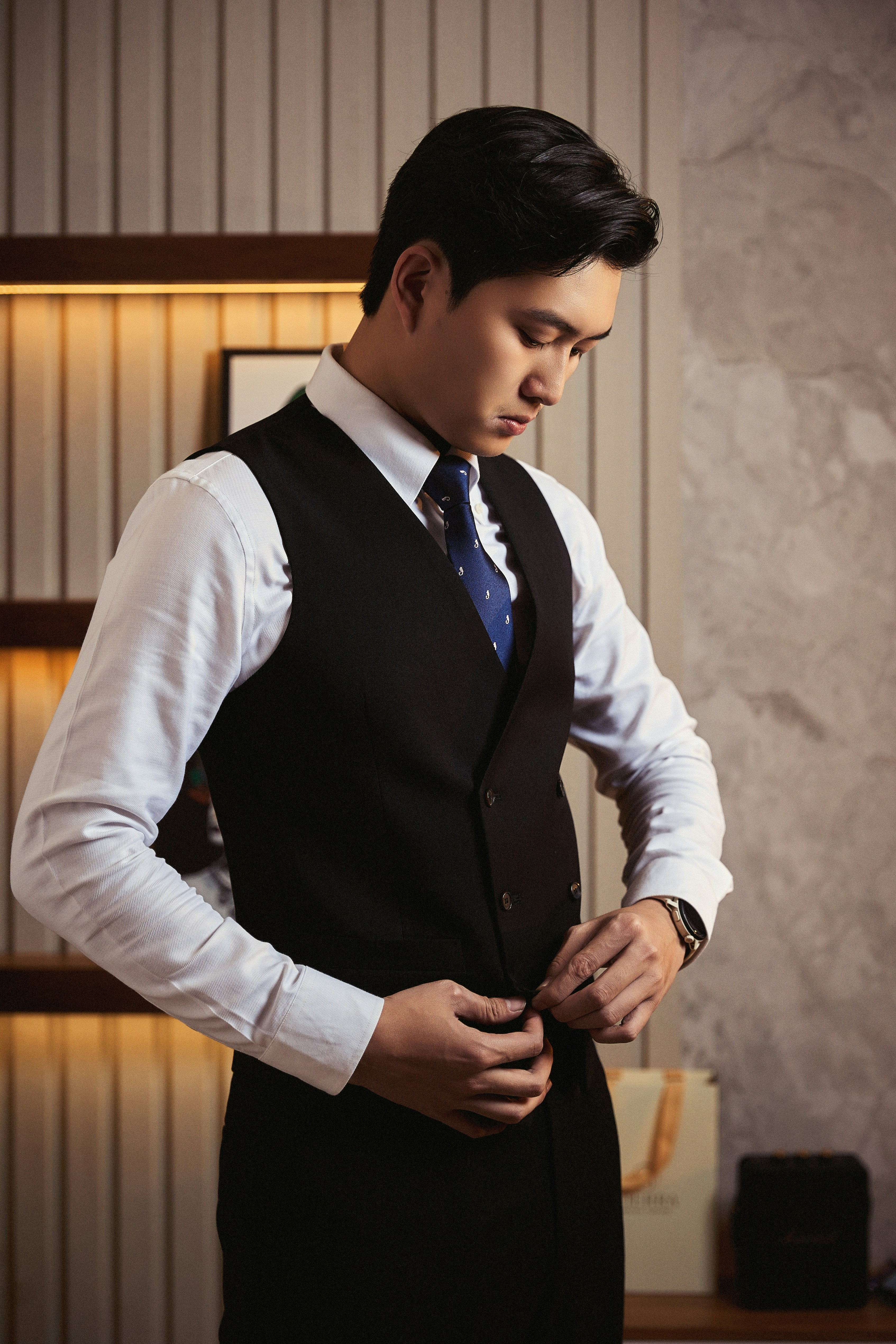 Taylor-made Quiet Power: A Groom-to-Be Adjusts the Suit in Soft Studio Light