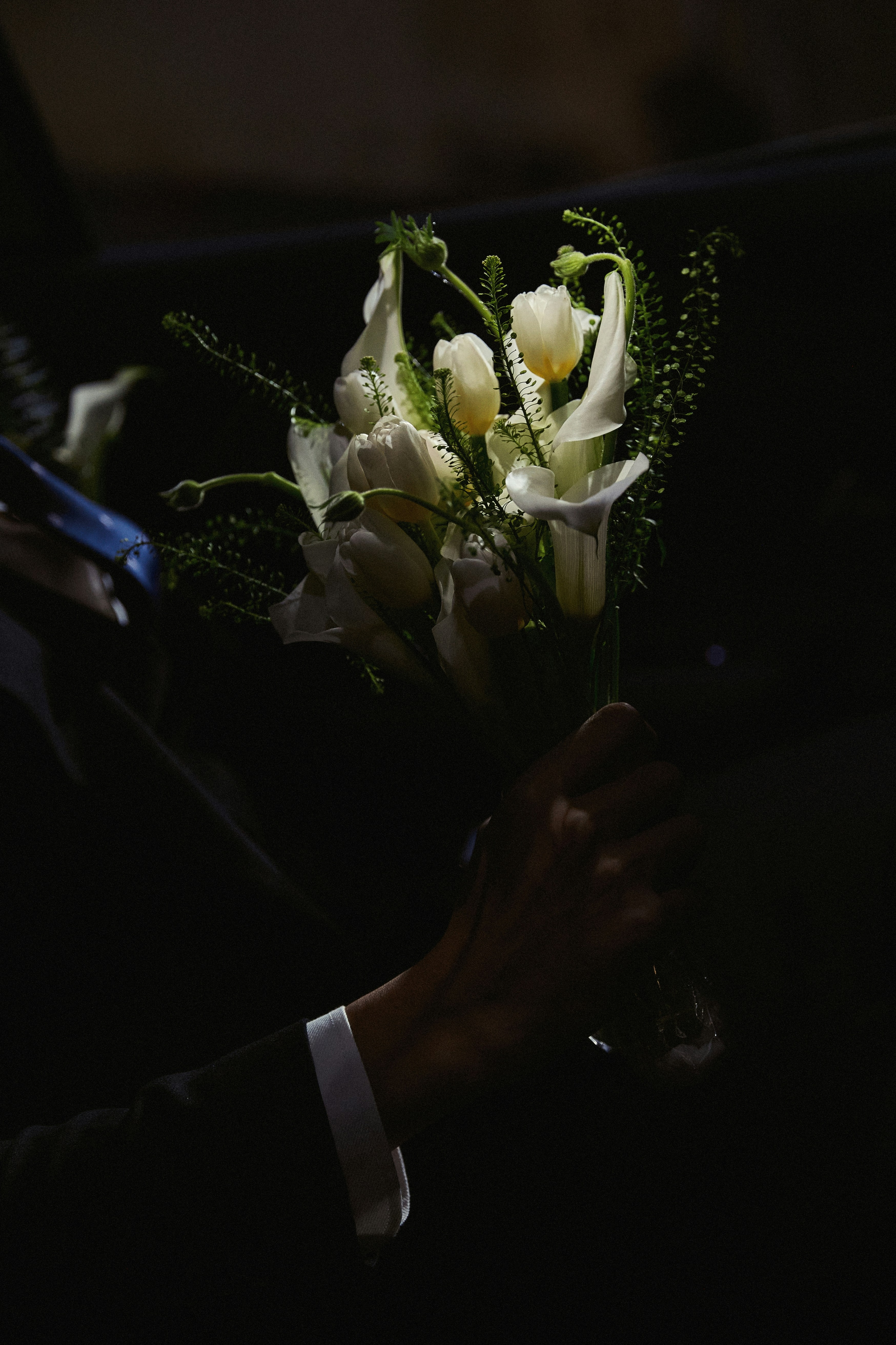 Bouquet in the Spotlight: A Quiet Moment of Wedding Bouquet and Hands
