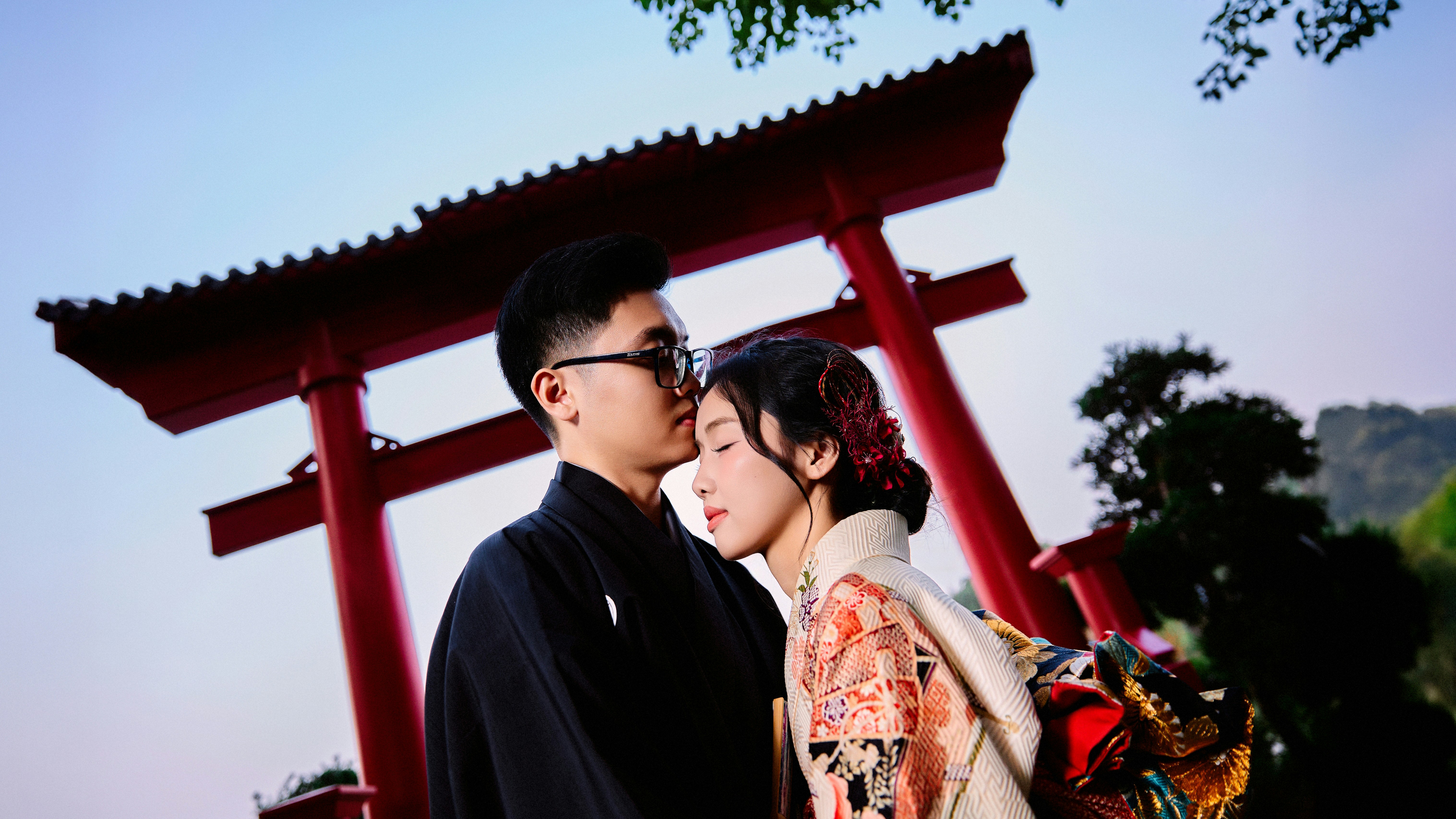 Bride and Groom in Traditional Kimono under a Red Torii